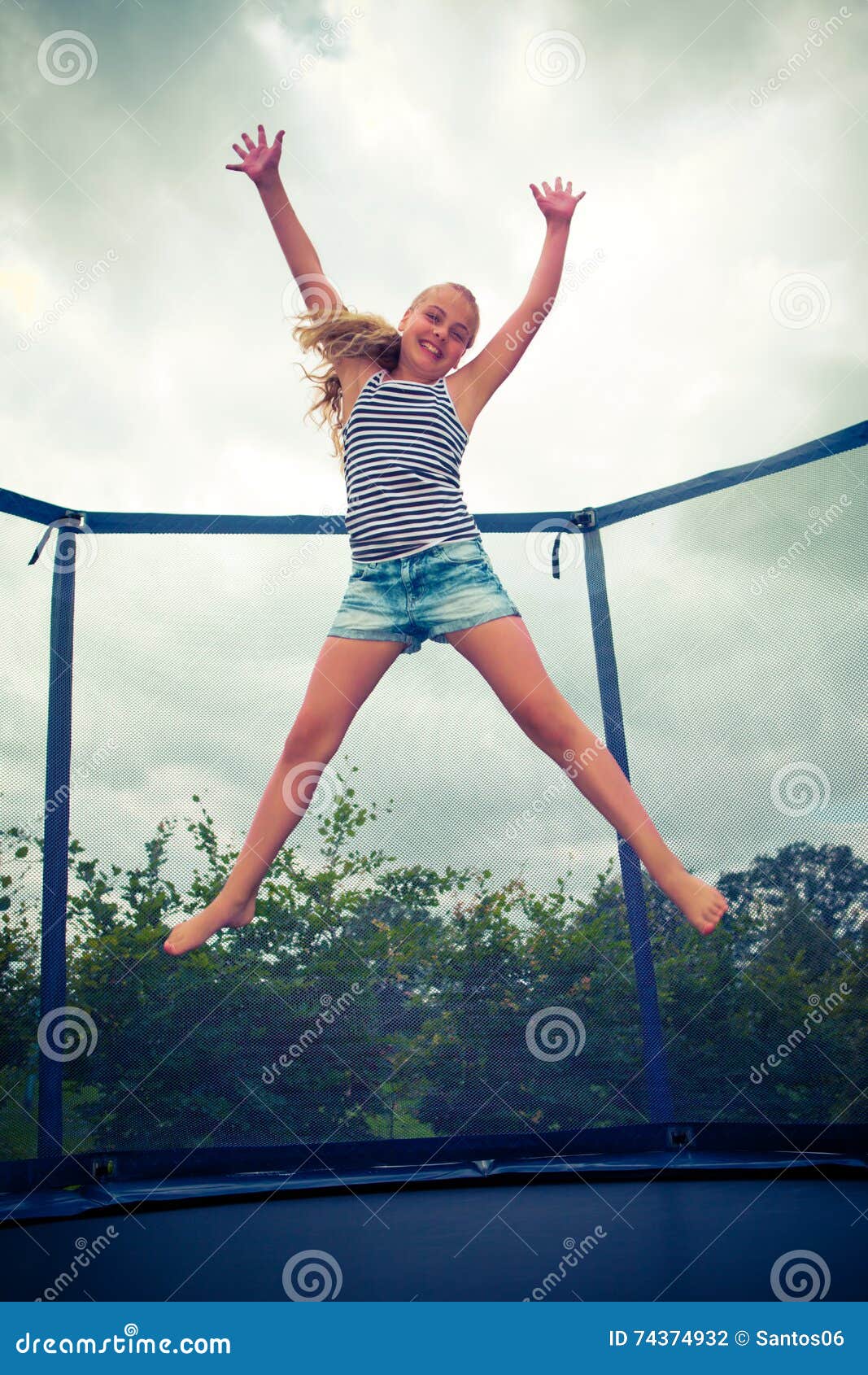 Jumping on a trampoline stock photo. Image of excitement - 74374932
