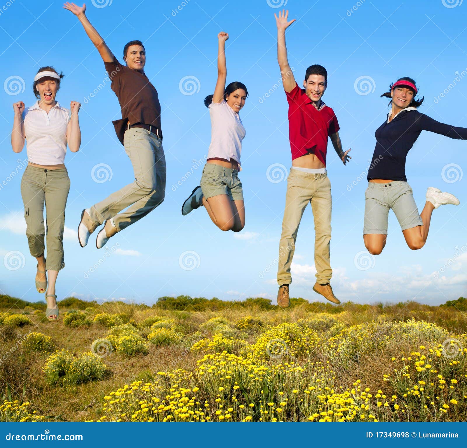 Jumping Young People Happy Group on Yellow Flowers Stock Photo - Image ...