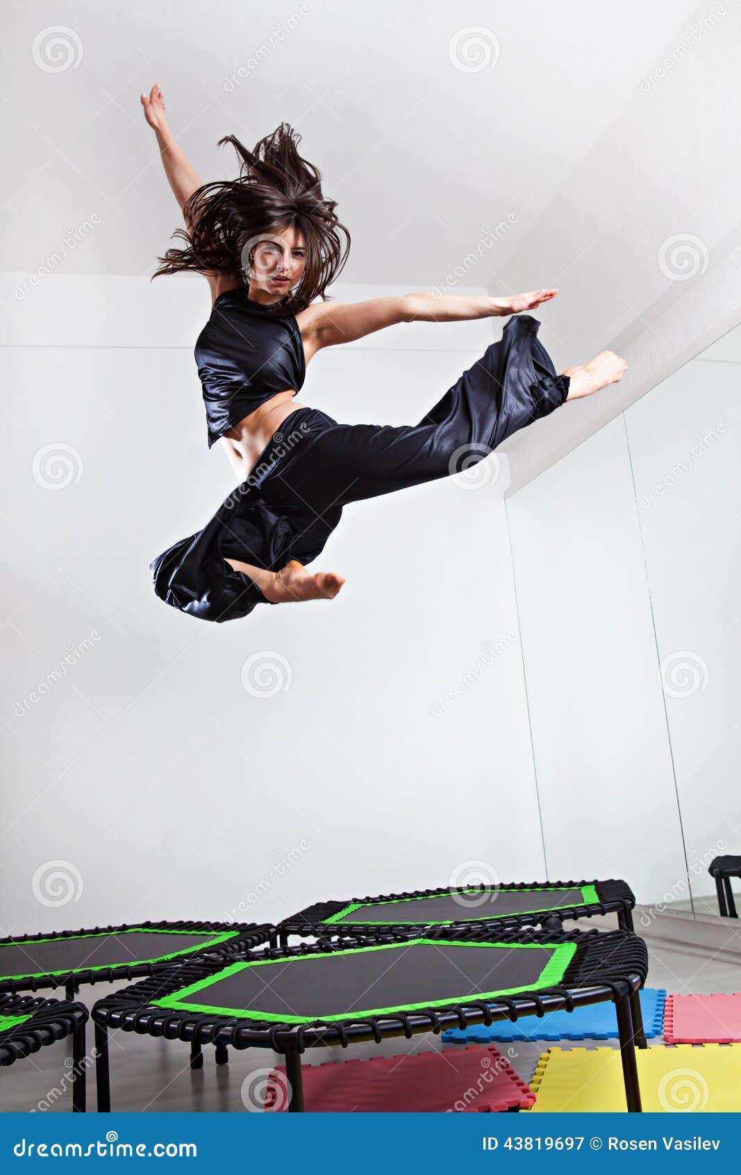 Jumping Young Woman on a Trampoline Stock Image - Image of body ...