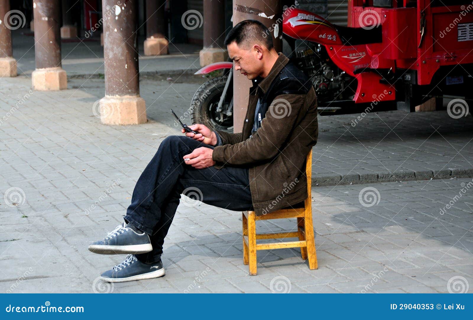 Jun Le, China: Man Using Cellphone Editorial Stock Photo - Image of ...