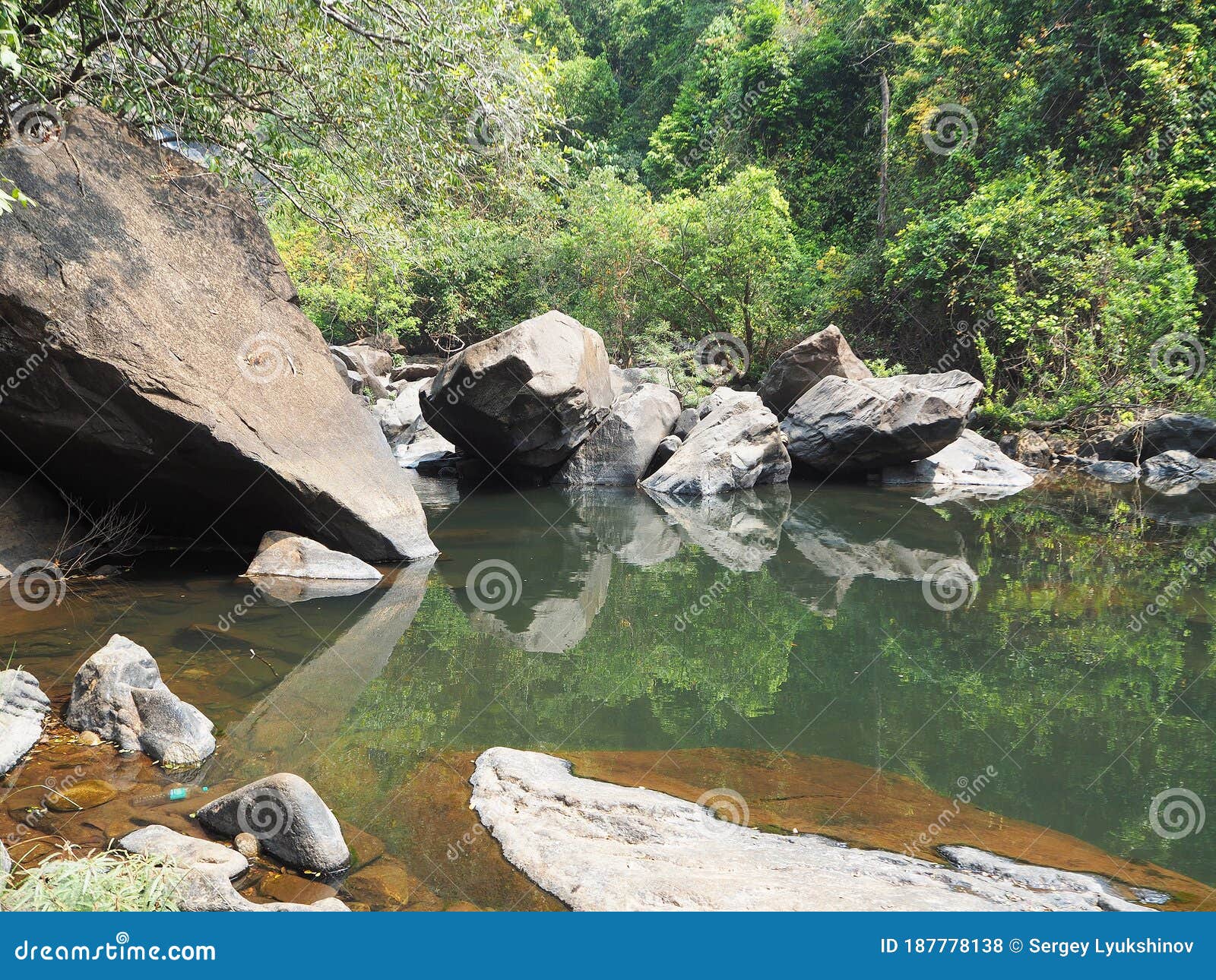 In the Jungle, a Clear River among Huge Boulders and Stones Stock Photo ...