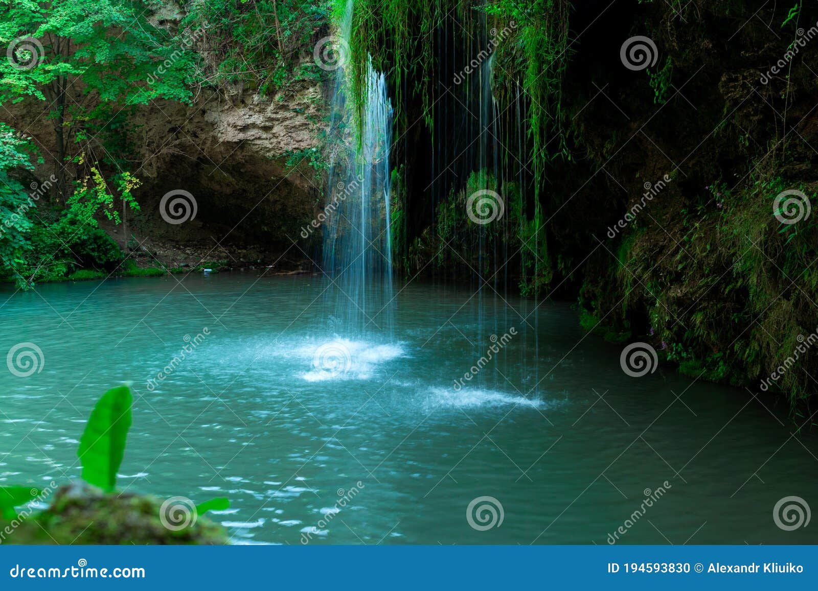 Jungle Landscape With Flowing Turquoise Water Of A Cascading Waterfall