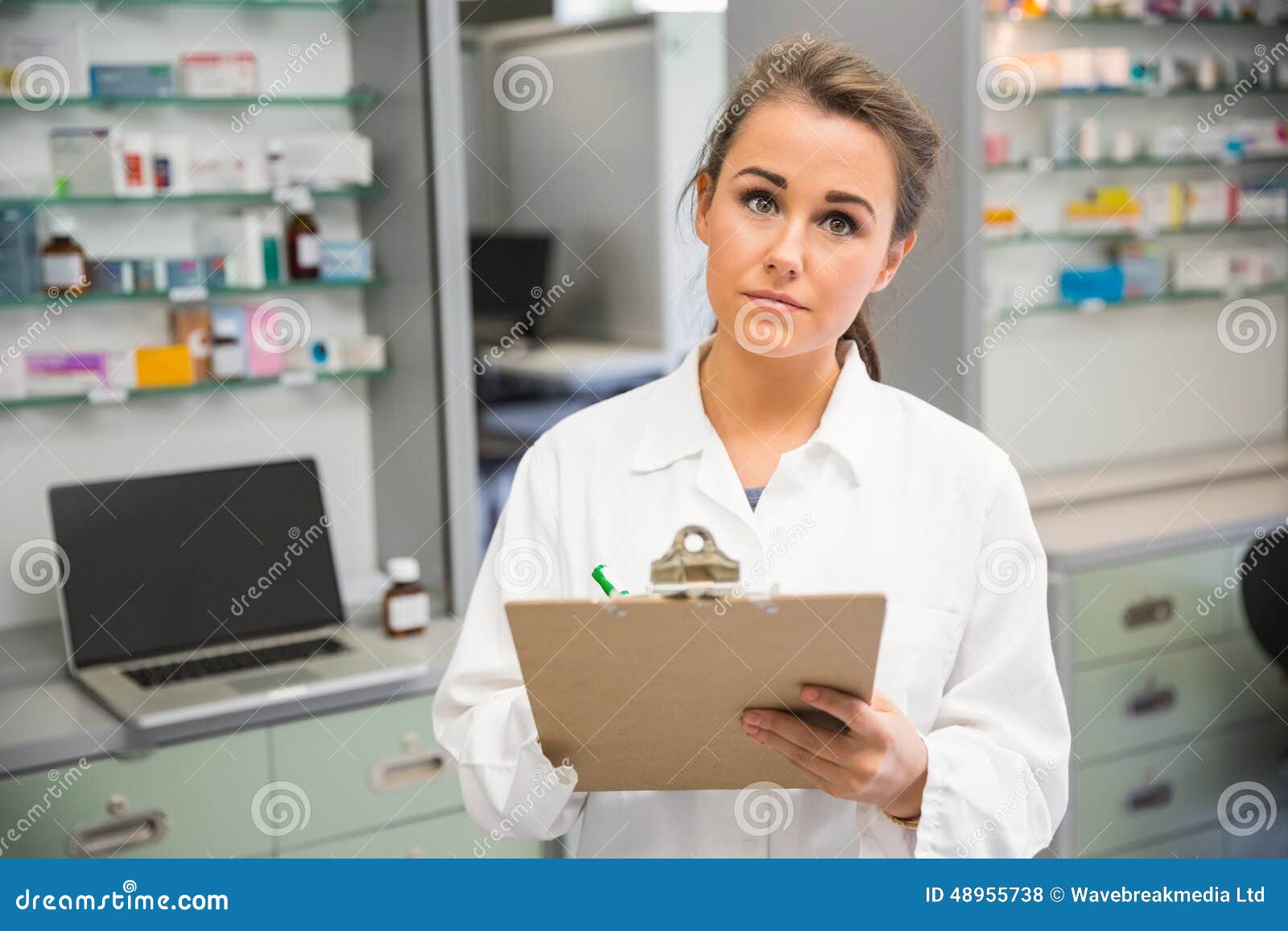 Junior Pharmacist Writing on Clipboard Stock Photo - Image of ...