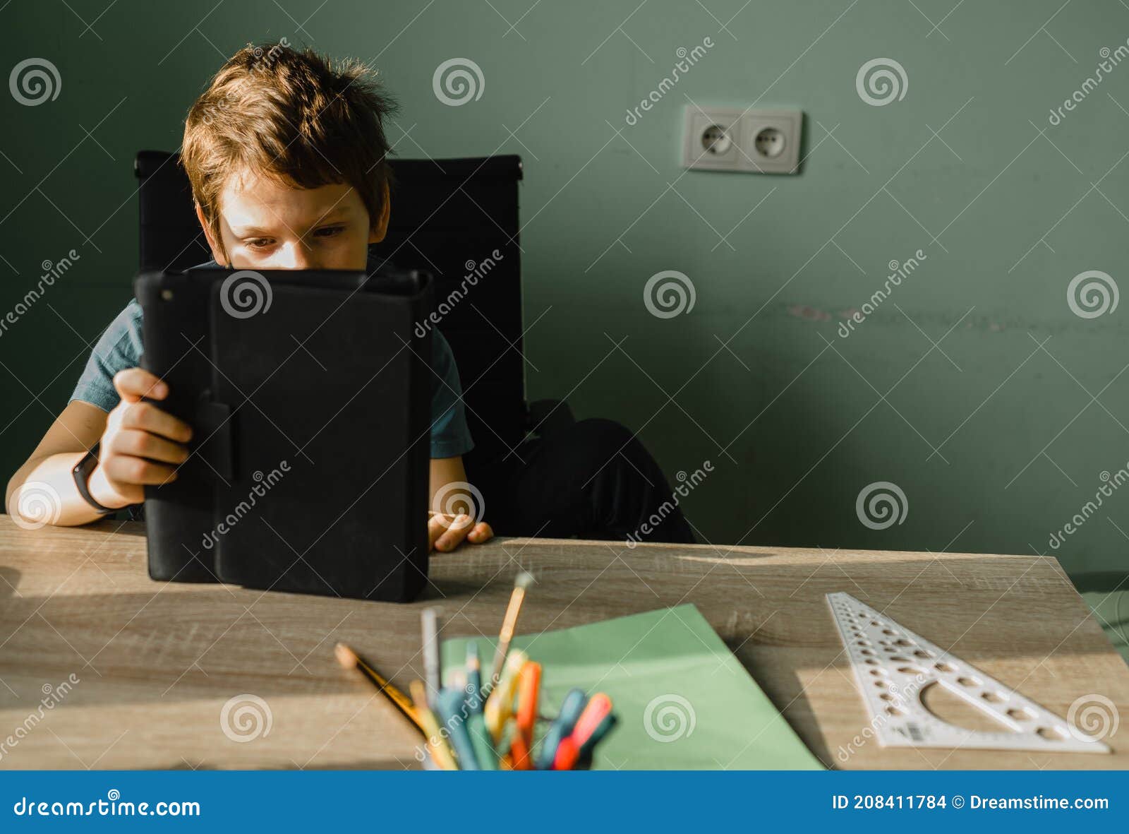 Junior School Boy Using Tablet at Home, Growing Up with Technology ...