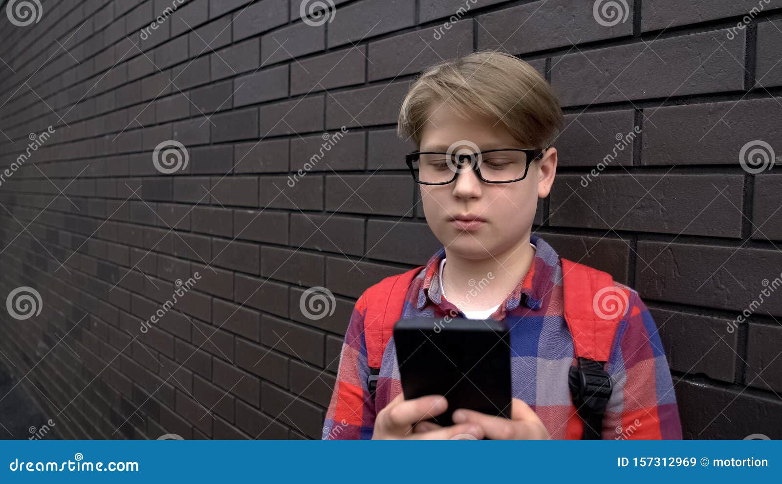 Junior Student Using Mobile Phone Hiding in Backyard, Addiction To ...