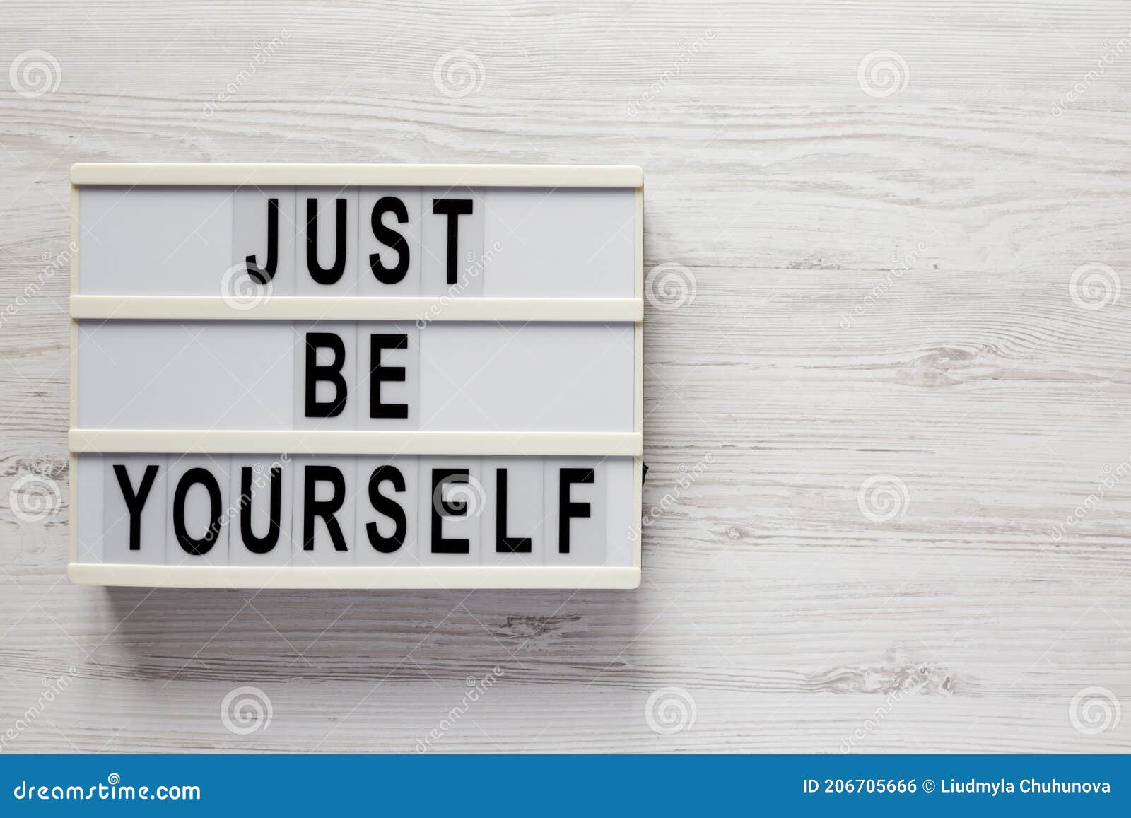 `Just Be Yourself` on a Lightbox on a White Wooden Surface, Top View ...