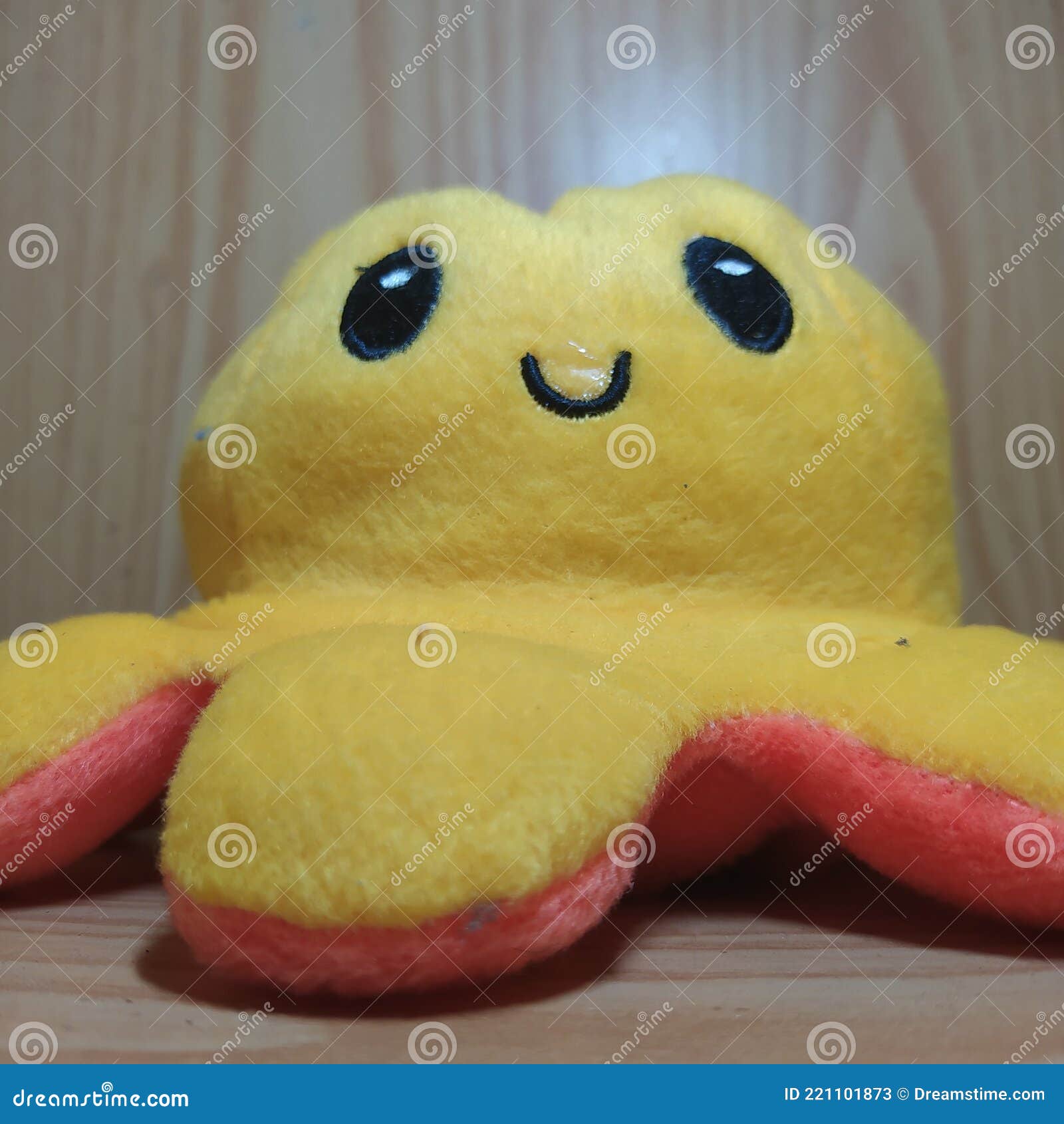 A Yellow Octopus With Blue Eyes And A Black Background Is Featured In A ...