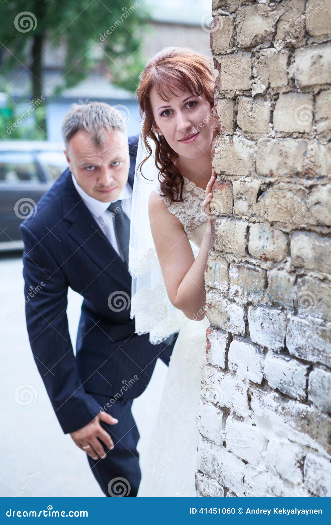 Just Married People Peek Around Corner of Brick Wall Stock Photo ...