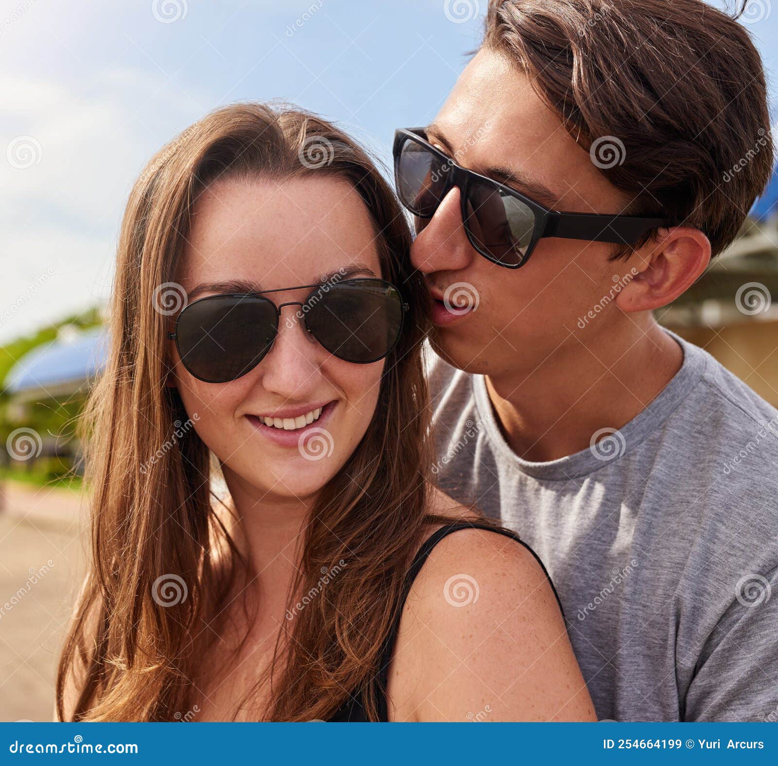 Just The Two Of Us An Affectionate Young Couple Standing Together Outside Stock Image Image