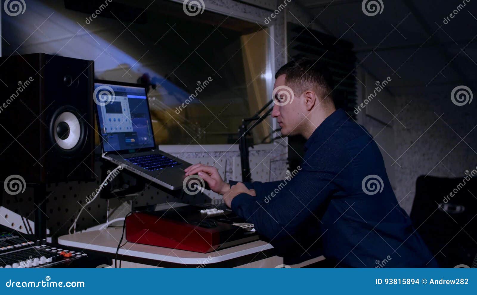 4K Young Sound Engineer in Recording Studio Using Laptop at the Mixing ...