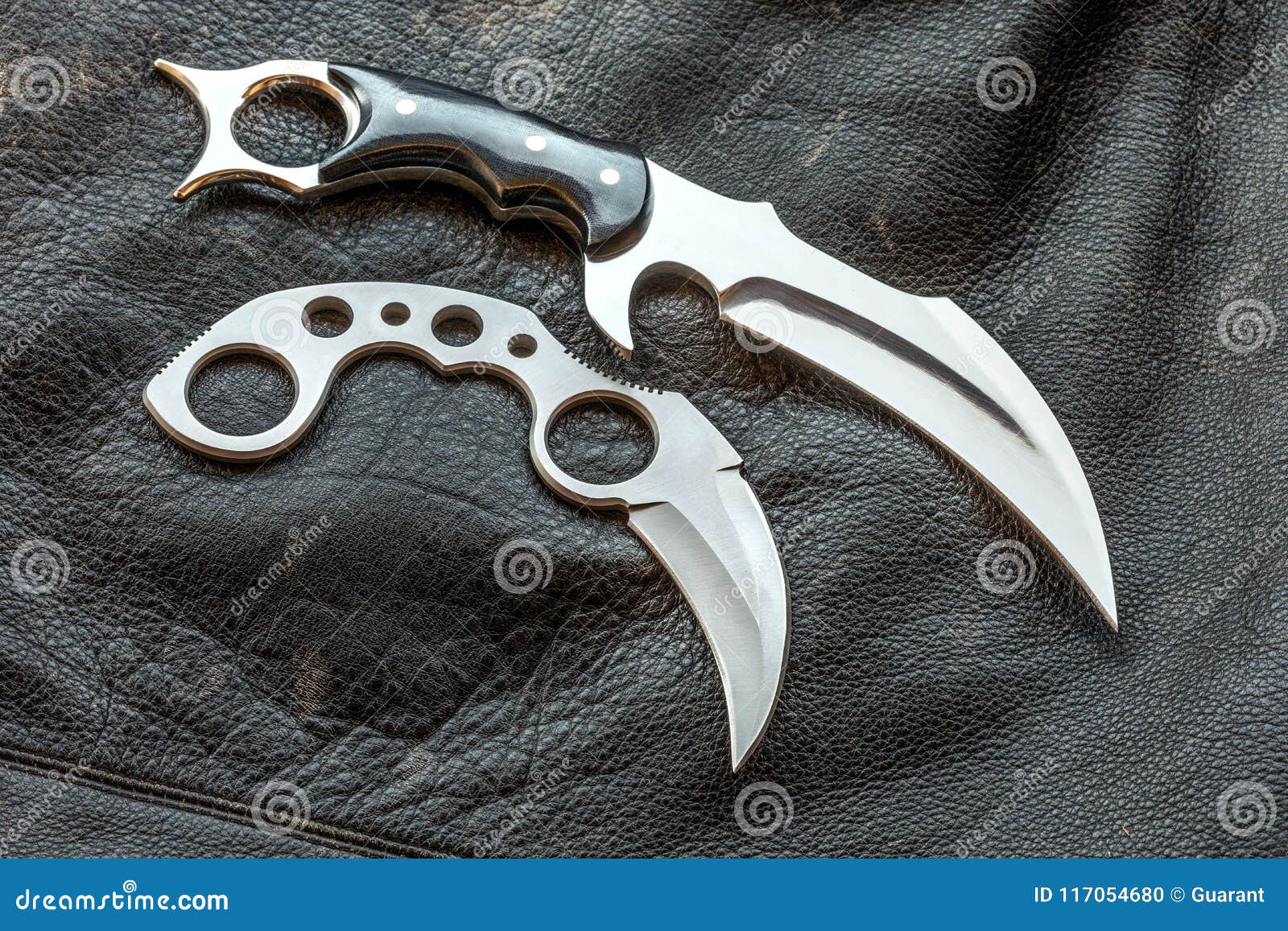 Karambit Knives Designer Made, on a Worn Leather Black Jacket Stock ...
