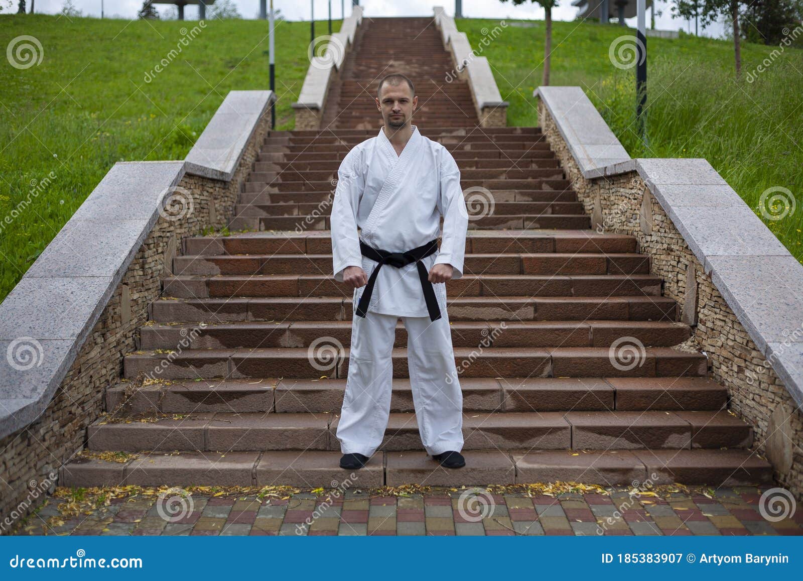 A Karate Trainer Stands and Holds His Hands in Fists in Front of Him ...