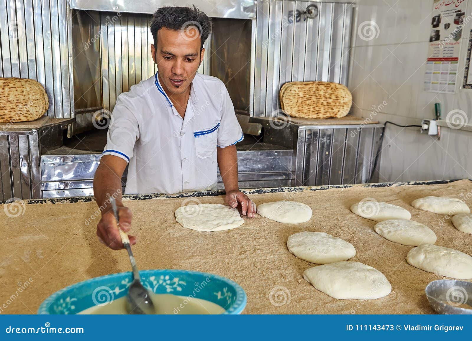 Baker Put Flattened Dough on Bakery Table, Kashan, Iran. Editorial ...