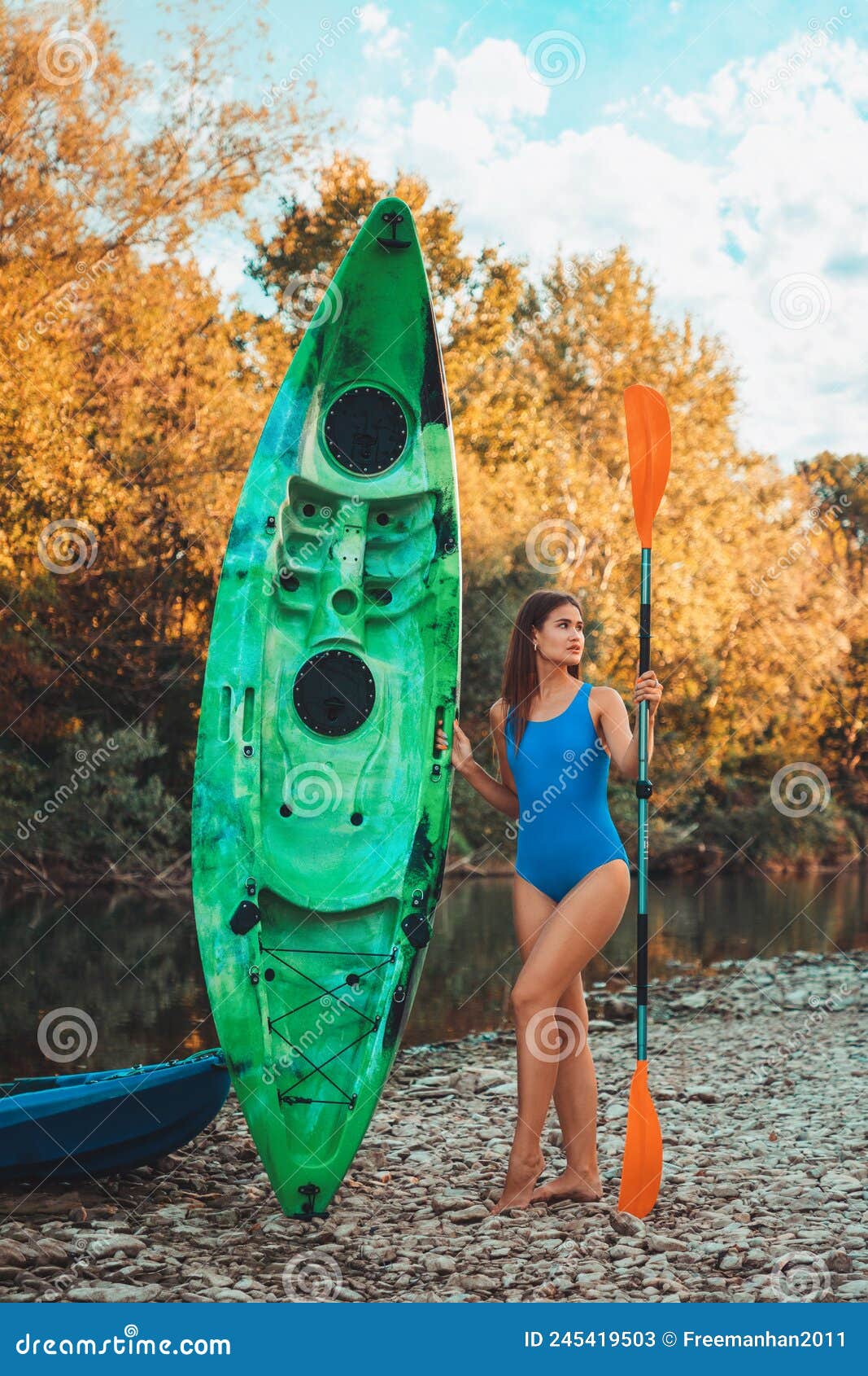 Kayaking On The River A Beautiful Young Woman In A Blue Swimsuit Poses