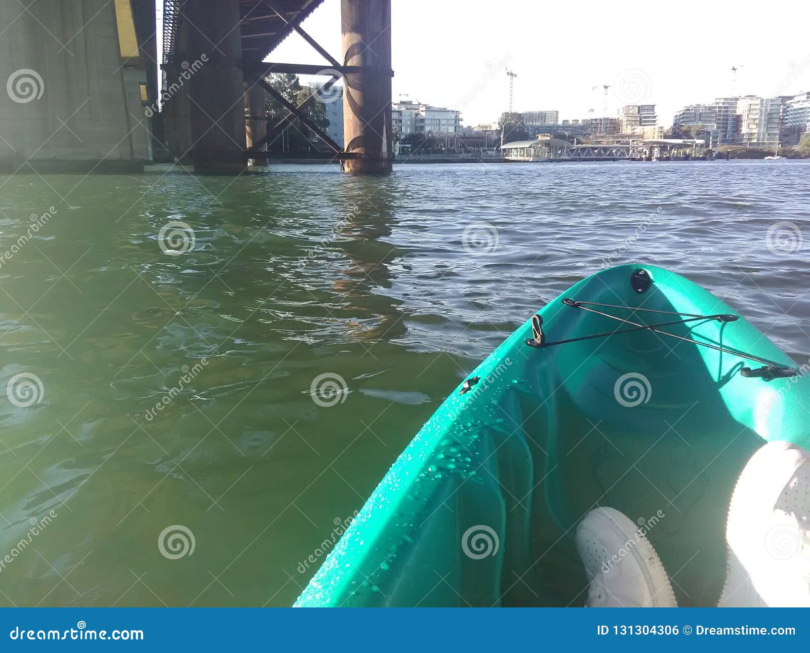 Kayaking under a bridge stock photo. Image of river - 131304306