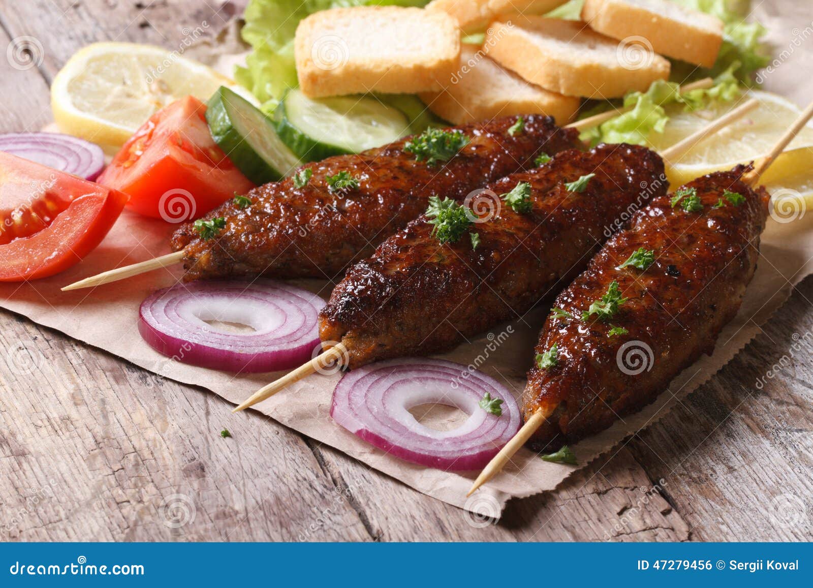 Kebabs with Vegetables on Paper Close-up Stock Photo - Image of green ...