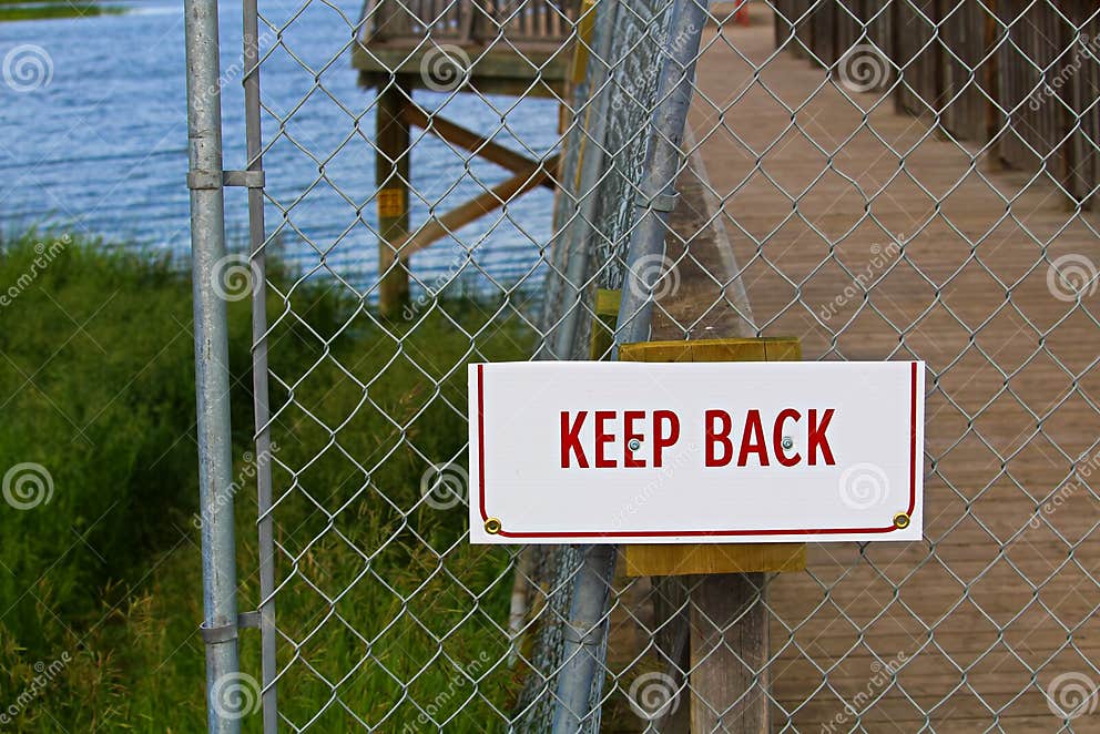 A Keep Back Sign on a Chain-link Fence Stock Photo - Image of alberta ...