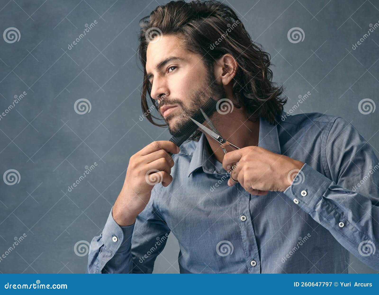 Keep that Beard in Check. Studio Shot of a Handsome Young Man Cutting ...