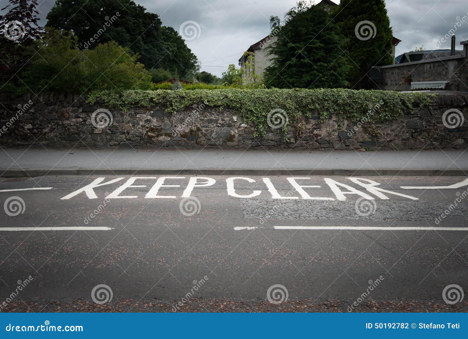 Keep Clear on an Asphalt Road Stock Photo - Image of symbol, concept ...