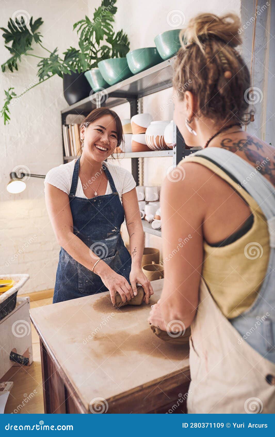 Keep Creating, Keep Smiling. Two Young Women Kneading Clay in a Pottery ...