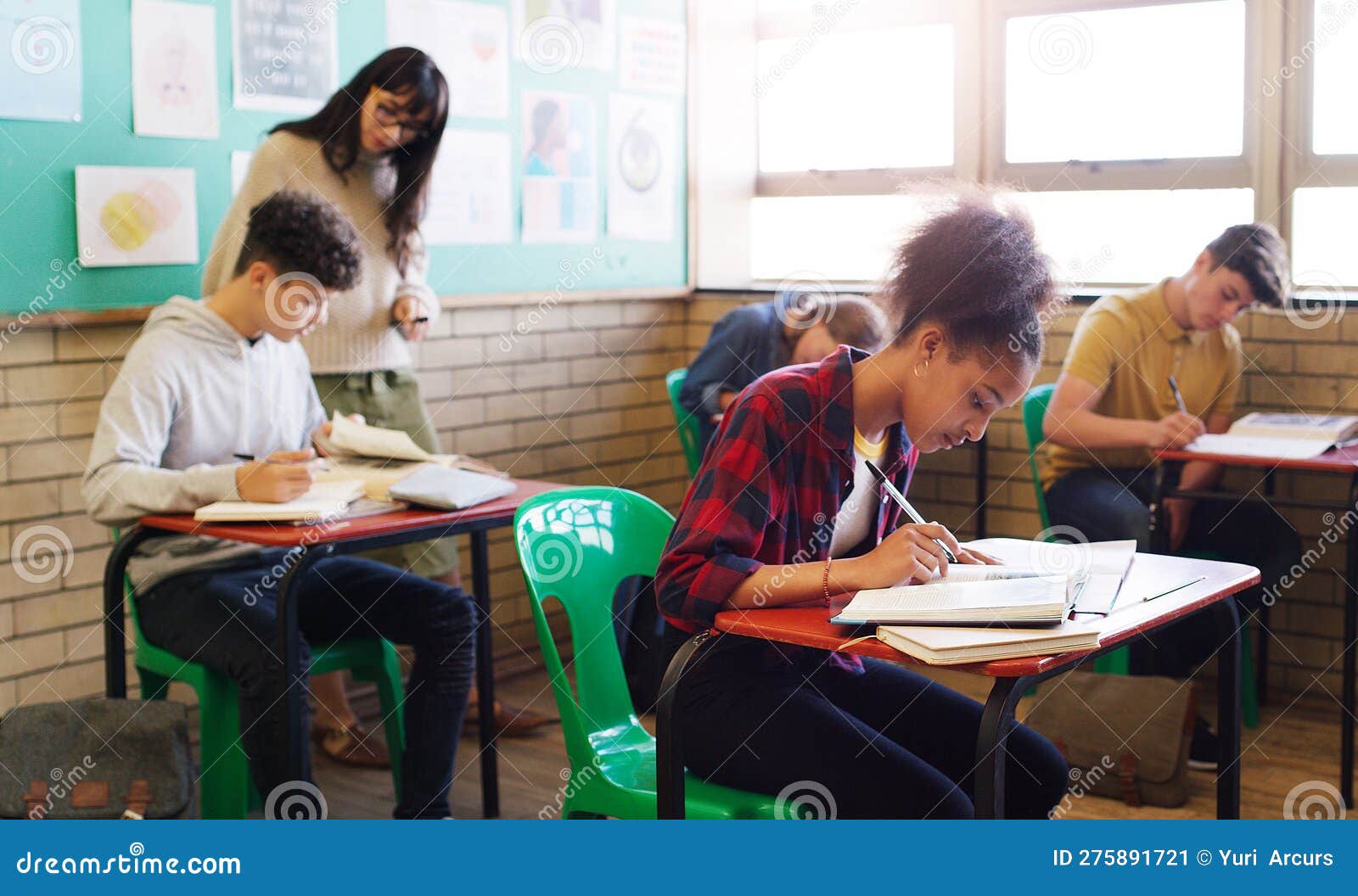 Keep Focusing on Your Work. a Cheerful Young Teacher Giving Class To a ... Keep Focusing on Your Work. a Cheerful Young Teacher Giving Class To a ...