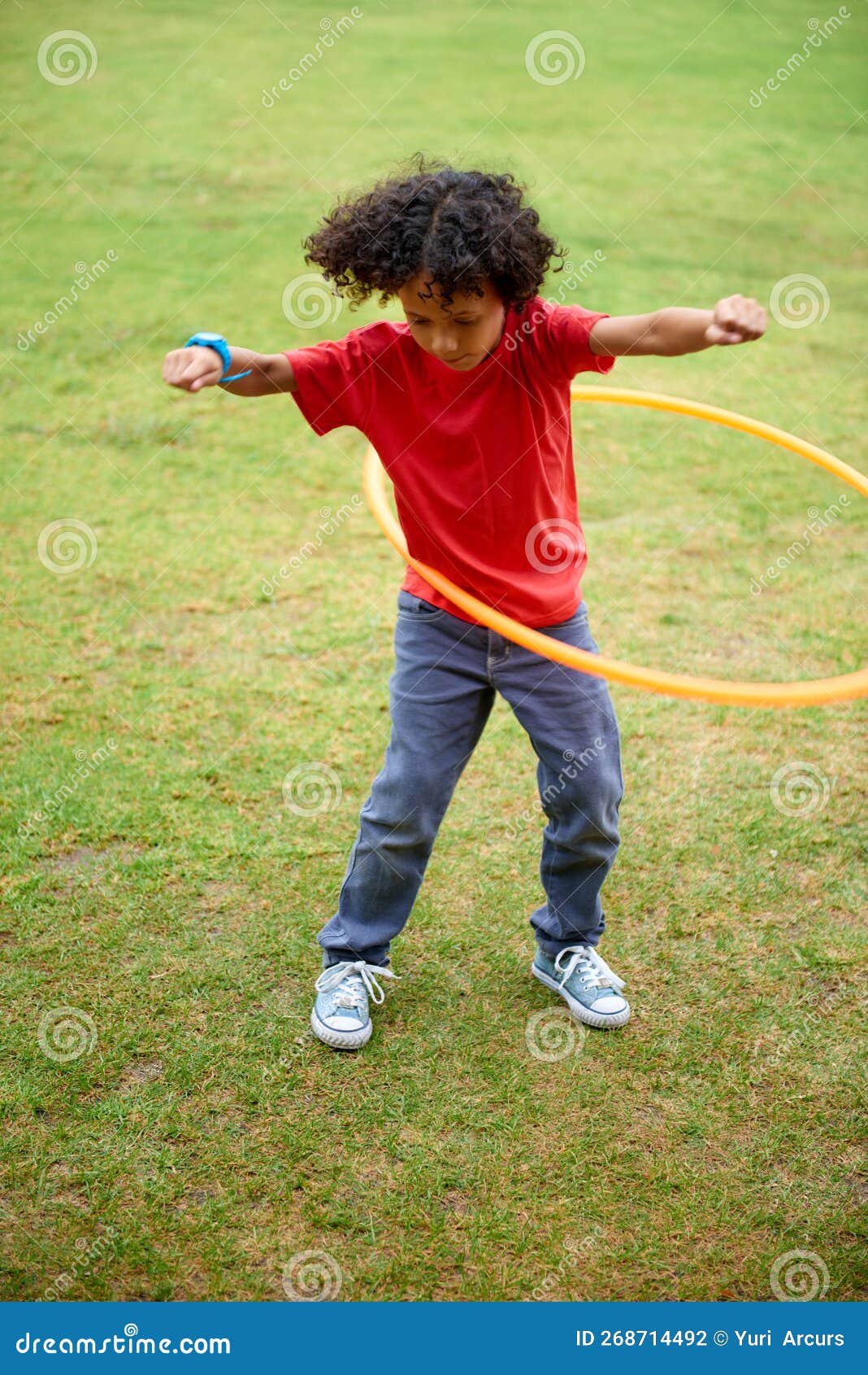 Keep it Going. Full Length Shot of a Young Boy Hula Hooping Outdoors ...