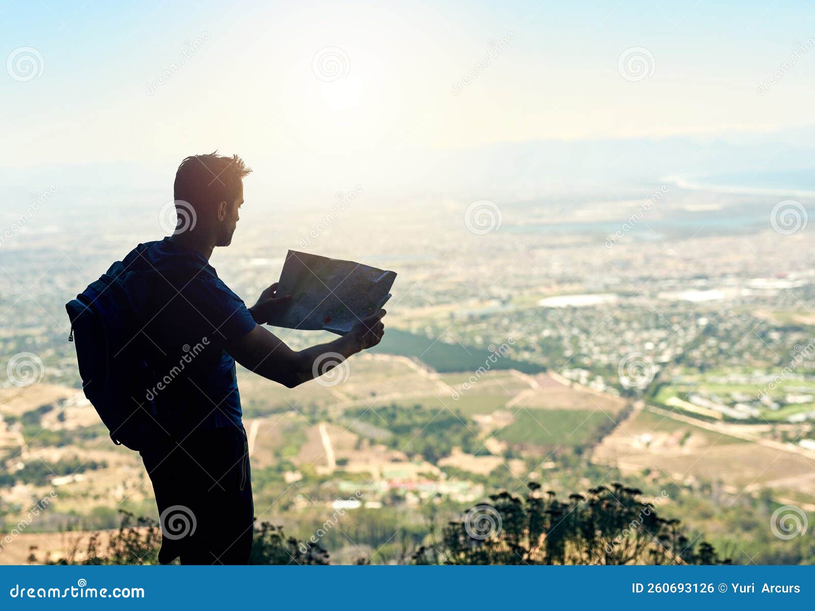 Keep Going, Keep Exploring. Rear View Shot of a Young Man Reading a Map while Standing at the ...