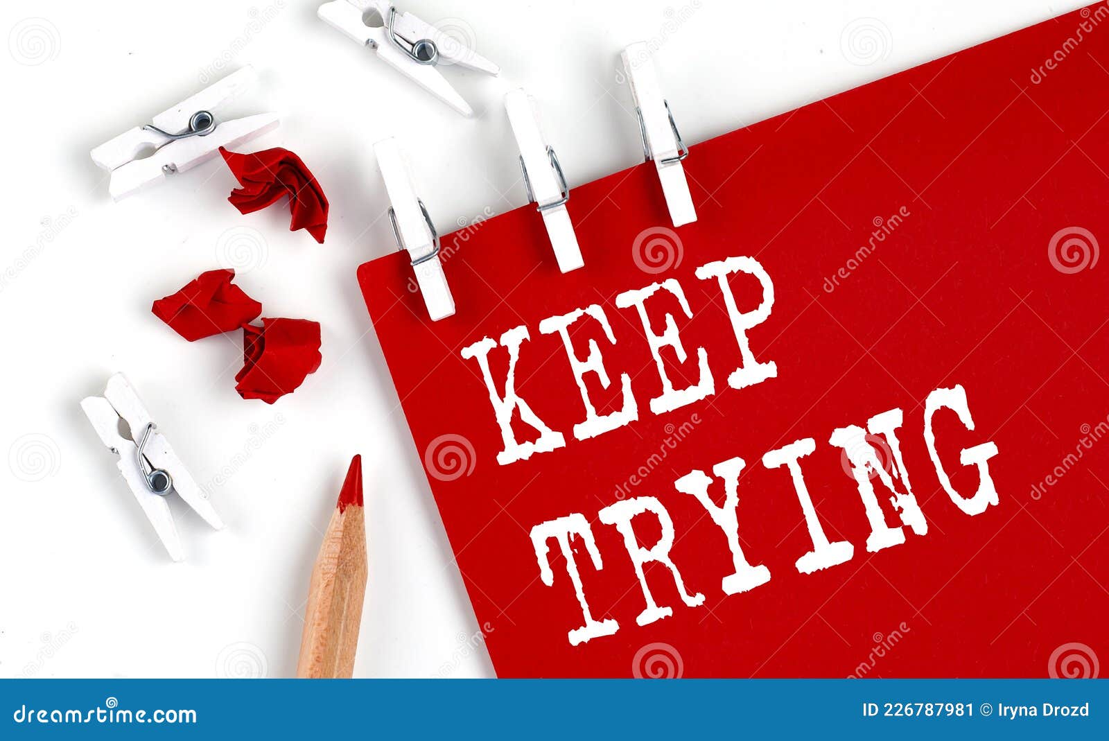 KEEP TRYING Text on Red Paper with Office Tools on White Background ...