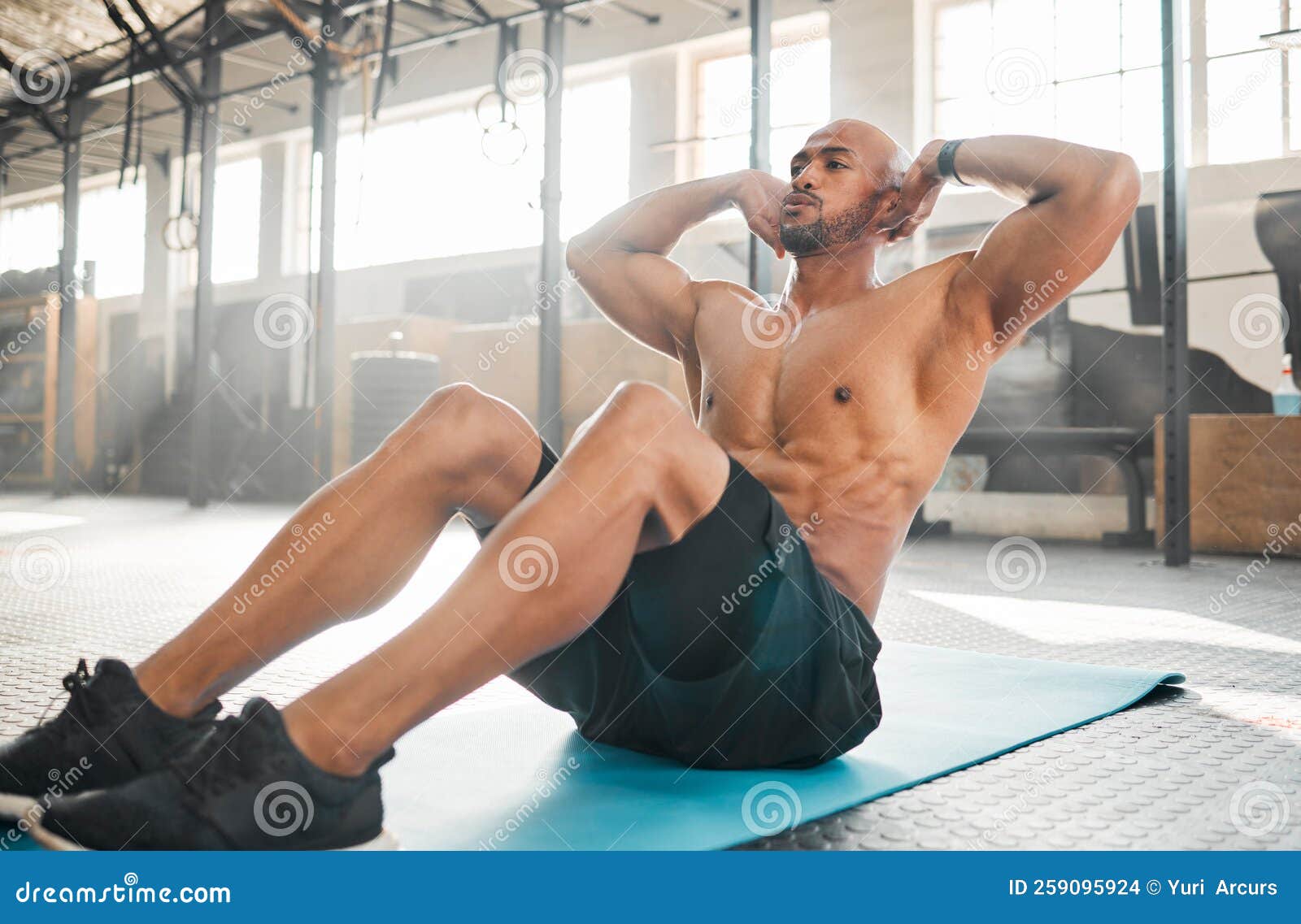 Keep Your Core Engaged. a Young Man Completing Crunches. Stock Photo ...