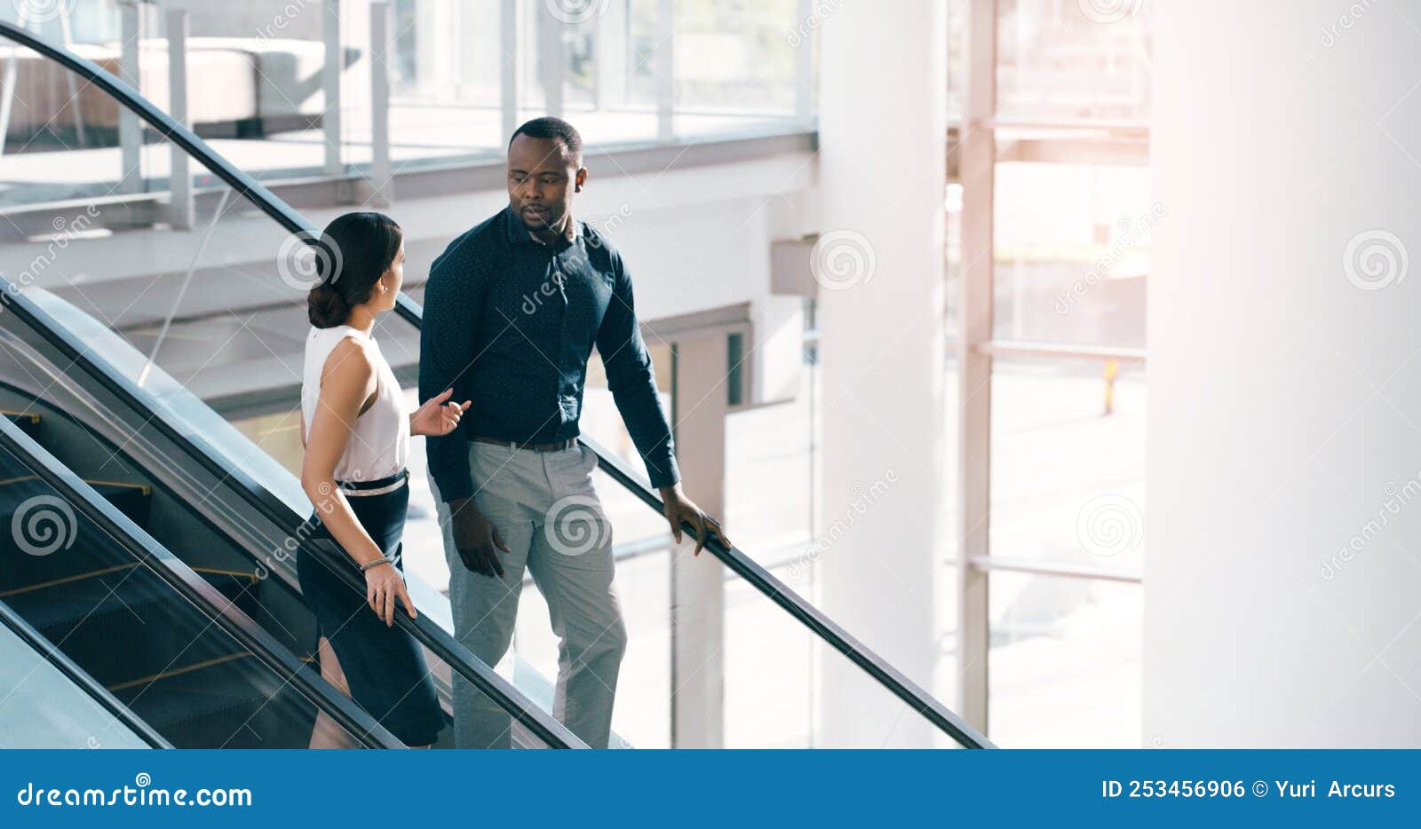 Keeping the Discussion Moving. Two Young Businesspeople Having a Chat ...