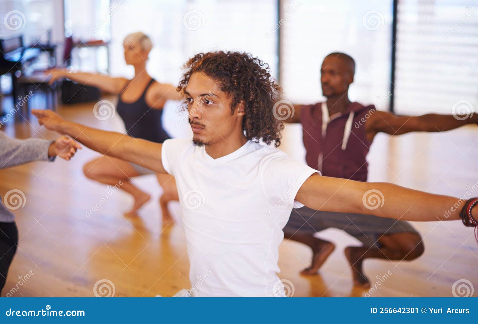 Keeping Fit and Flexible. a Group of Young Dancers Squatting in a Dance ...