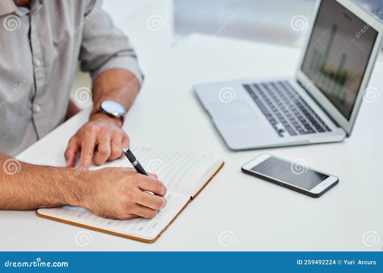 Keeping Track of My Work. a Businessman Making Notes in a Notebook ...