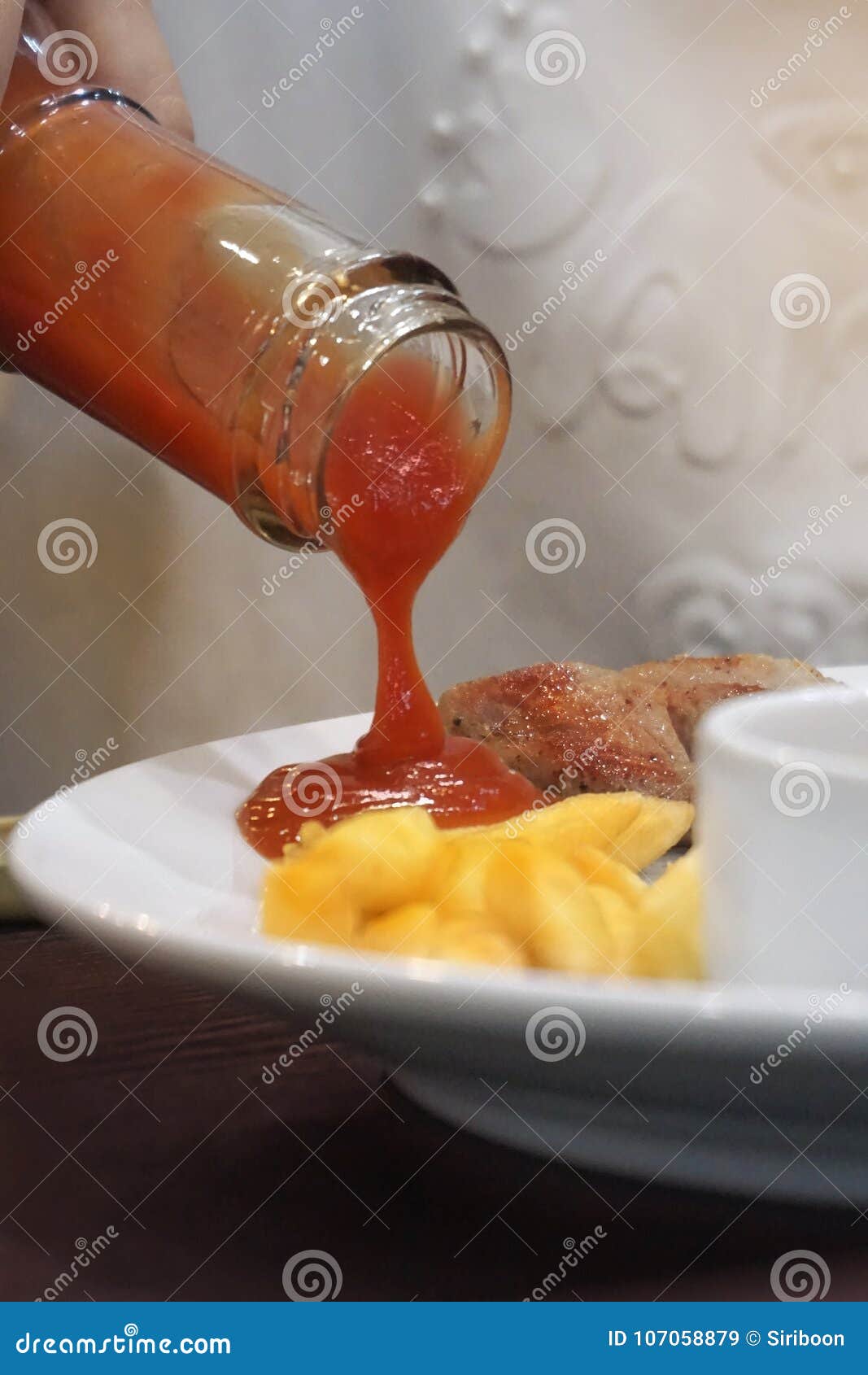 Ketchup Flow from the Bottle Onto a Plate of Steak and Fried Pot Stock ...