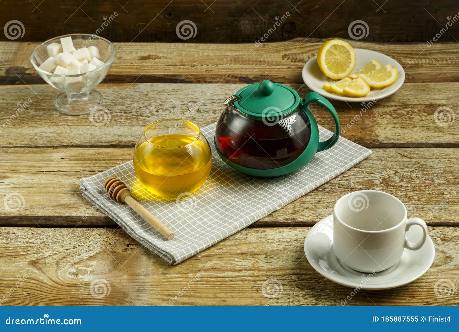 Kettle with Brewed Tea and Honey with Lemon and a Cup on the Table ...