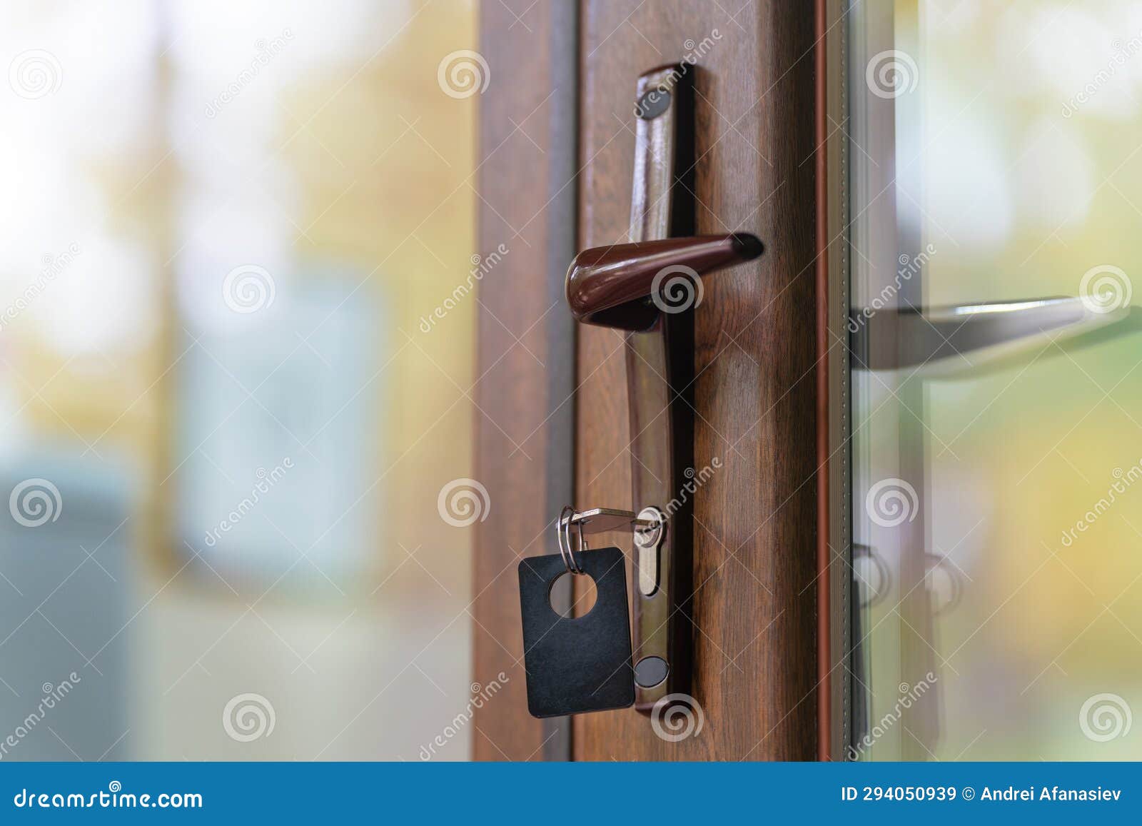 Key with Key Fob in the Keyhole of a Closed Door Stock Image - Image of ...