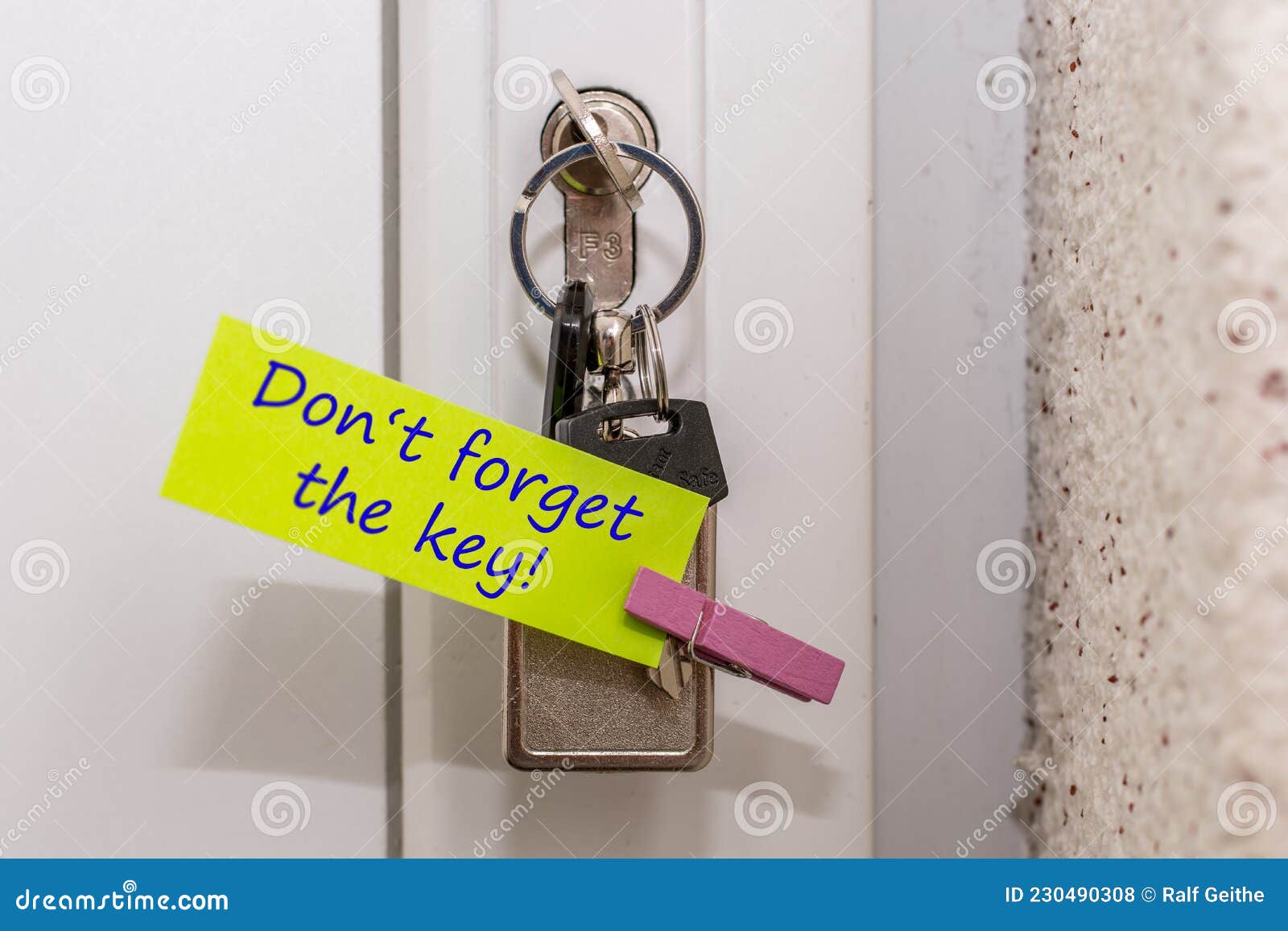 Key on the Front Door with the Note Not To Forget the Key Stock Photo ...