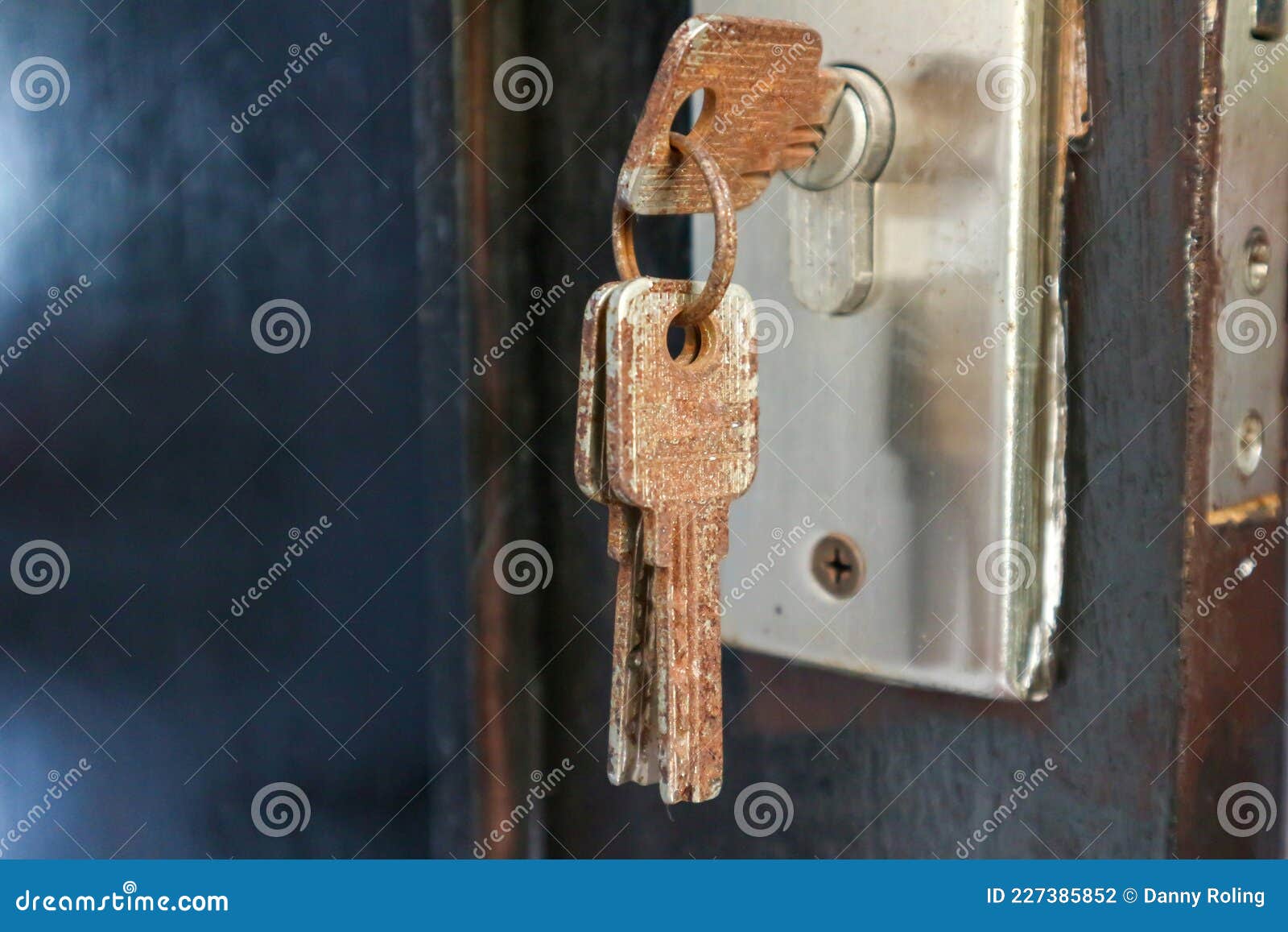 The Key Hanging in the Keyhole Stock Photo - Image of rusty, keyhole ...