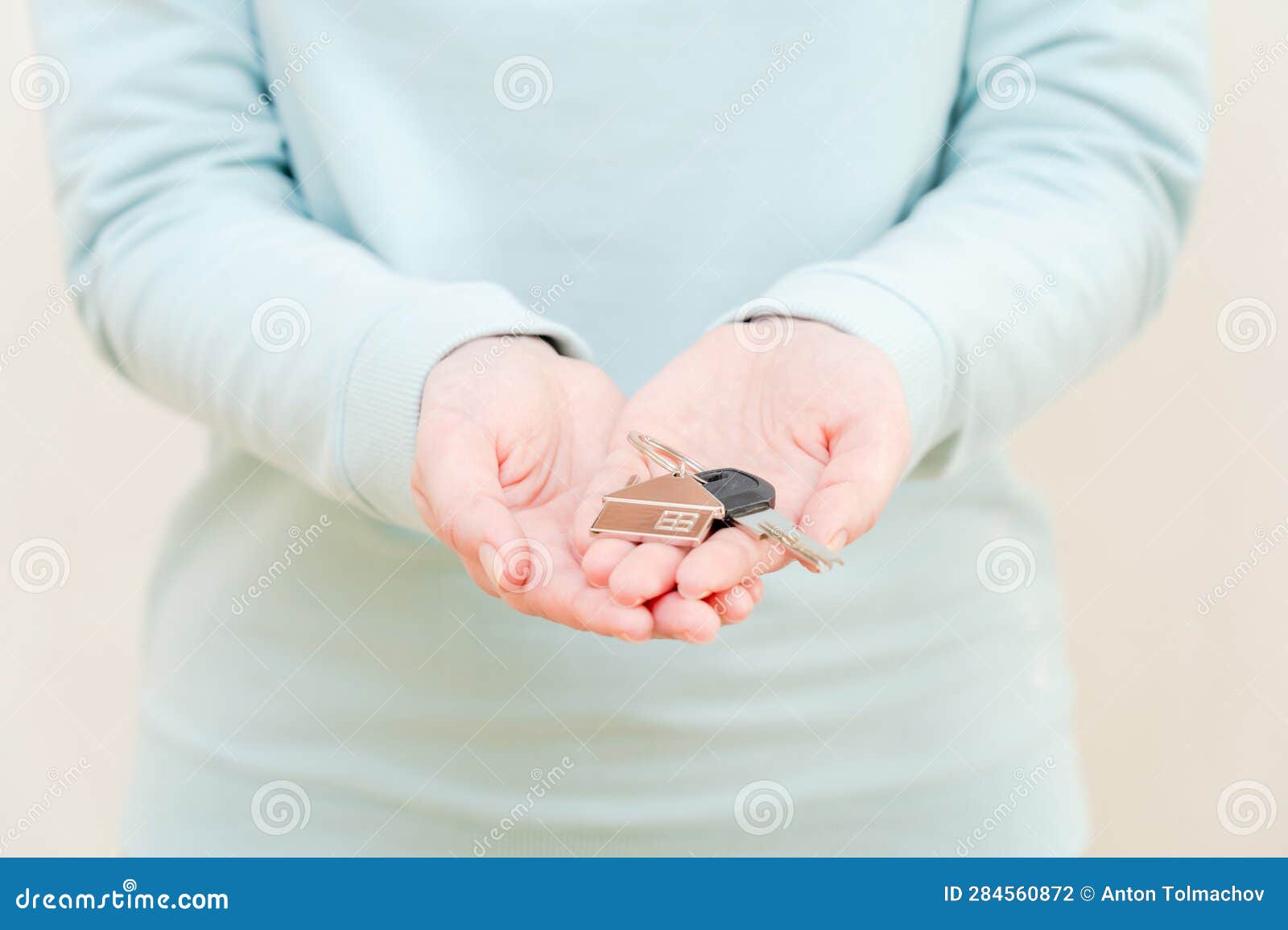 Key with Keychain in the Shape of the House in Hands Stock Photo ...