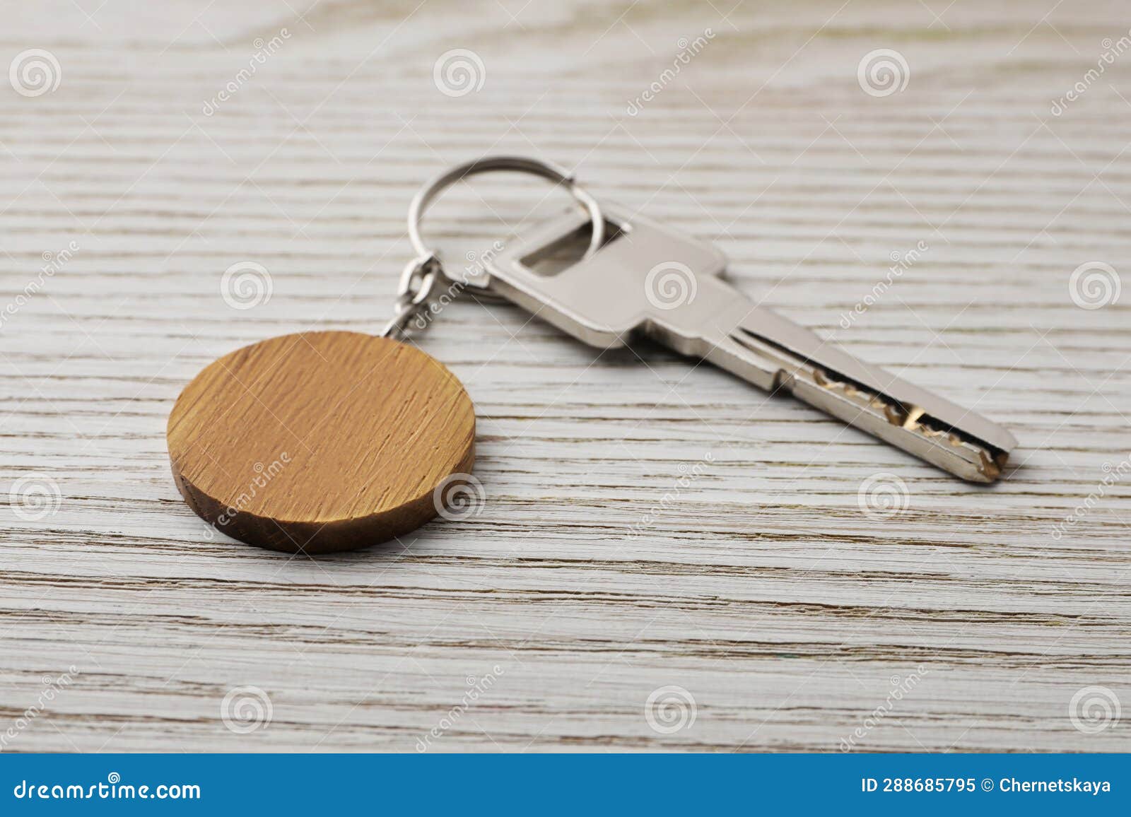 Key with Keychain in Shape of Smiley Face on Light Wooden Background ...