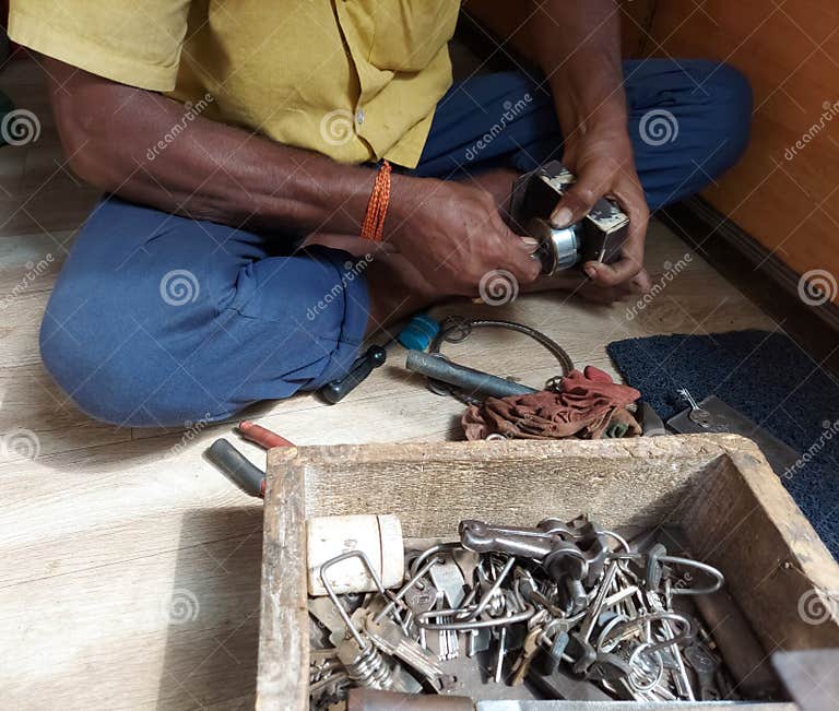 A Key Making Tool Box with a Background of Key Makers Hands Matching ...