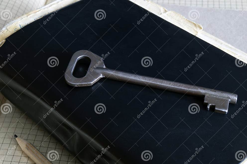A Key and an Old Leather-bound Book Stock Photo - Image of battered ...