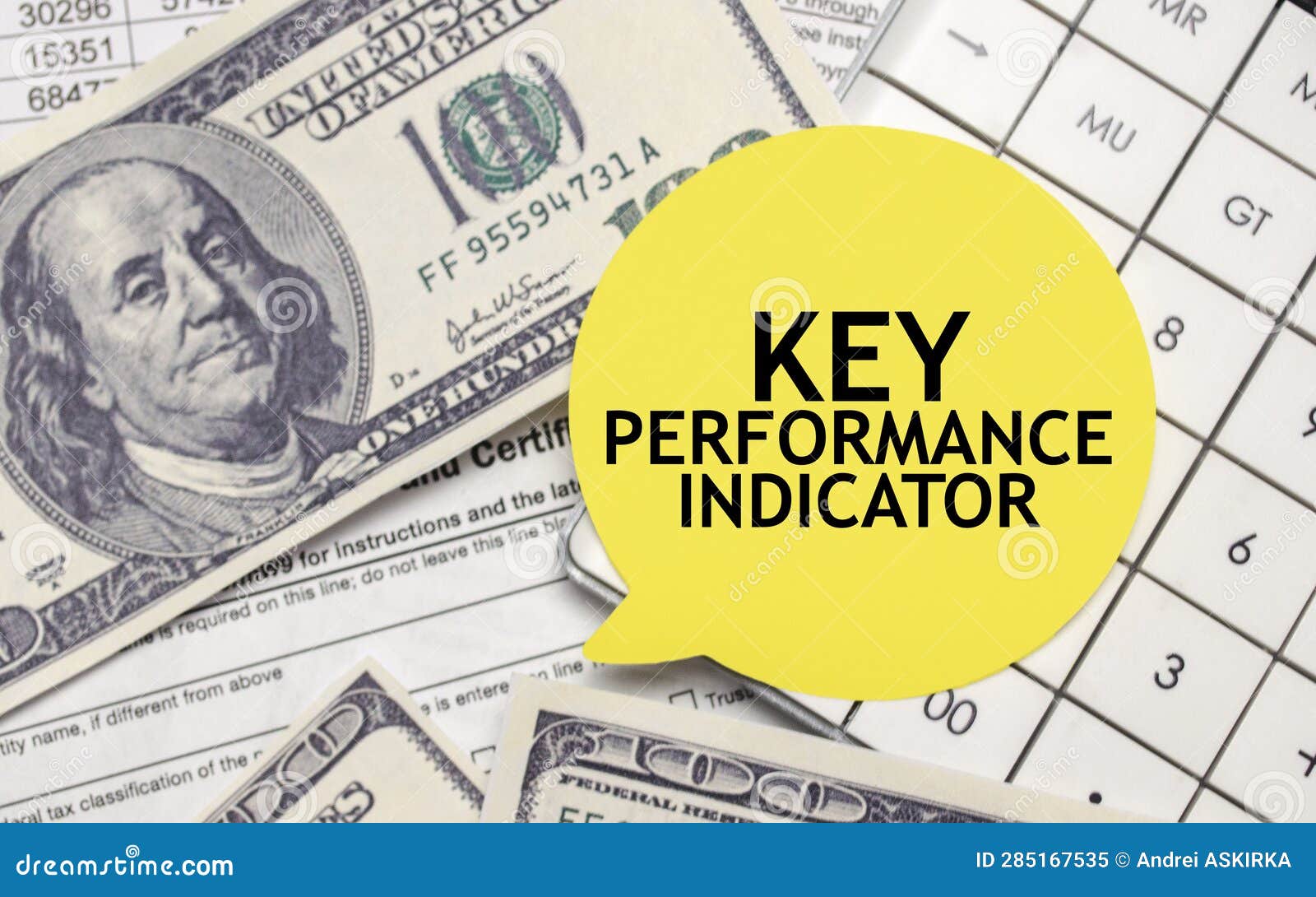 KEY PERFORMANCE INDICATOR Words on Yellow Sticker with Dollars and ...