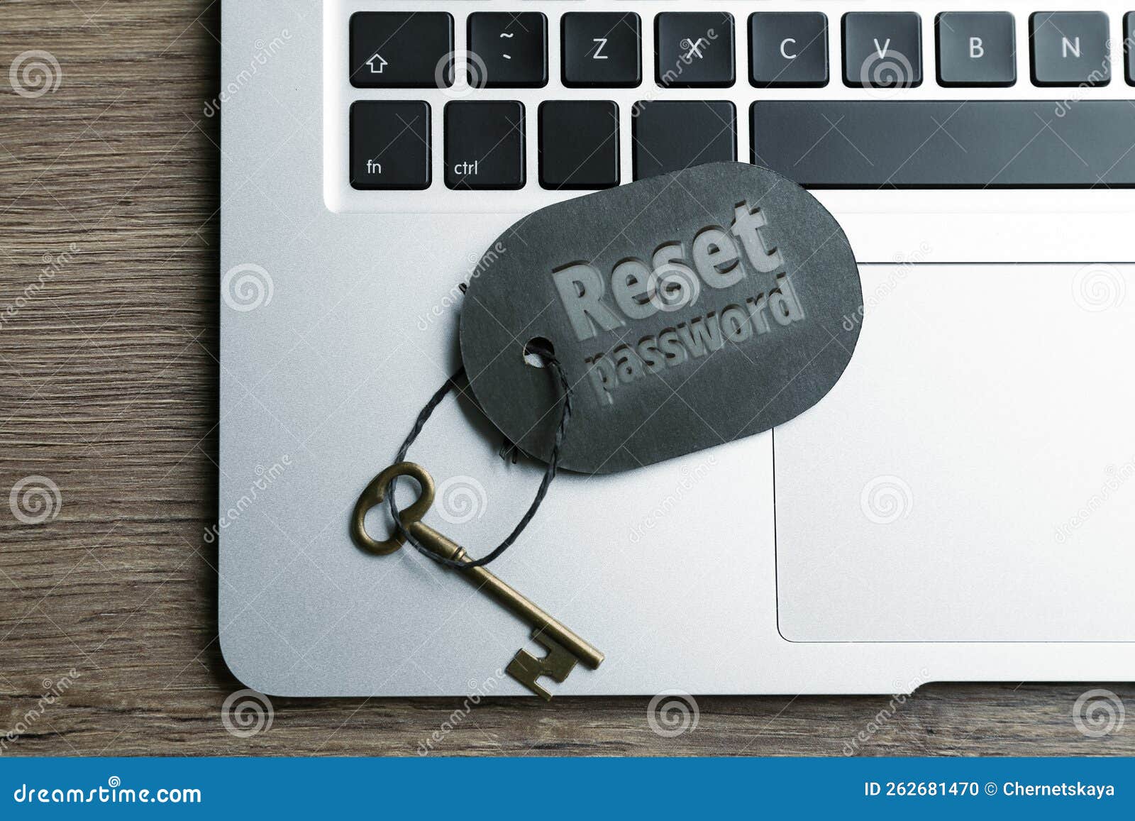 Key with Tag RESET PASSWORD and Laptop on Wooden Table, Top View Stock ...