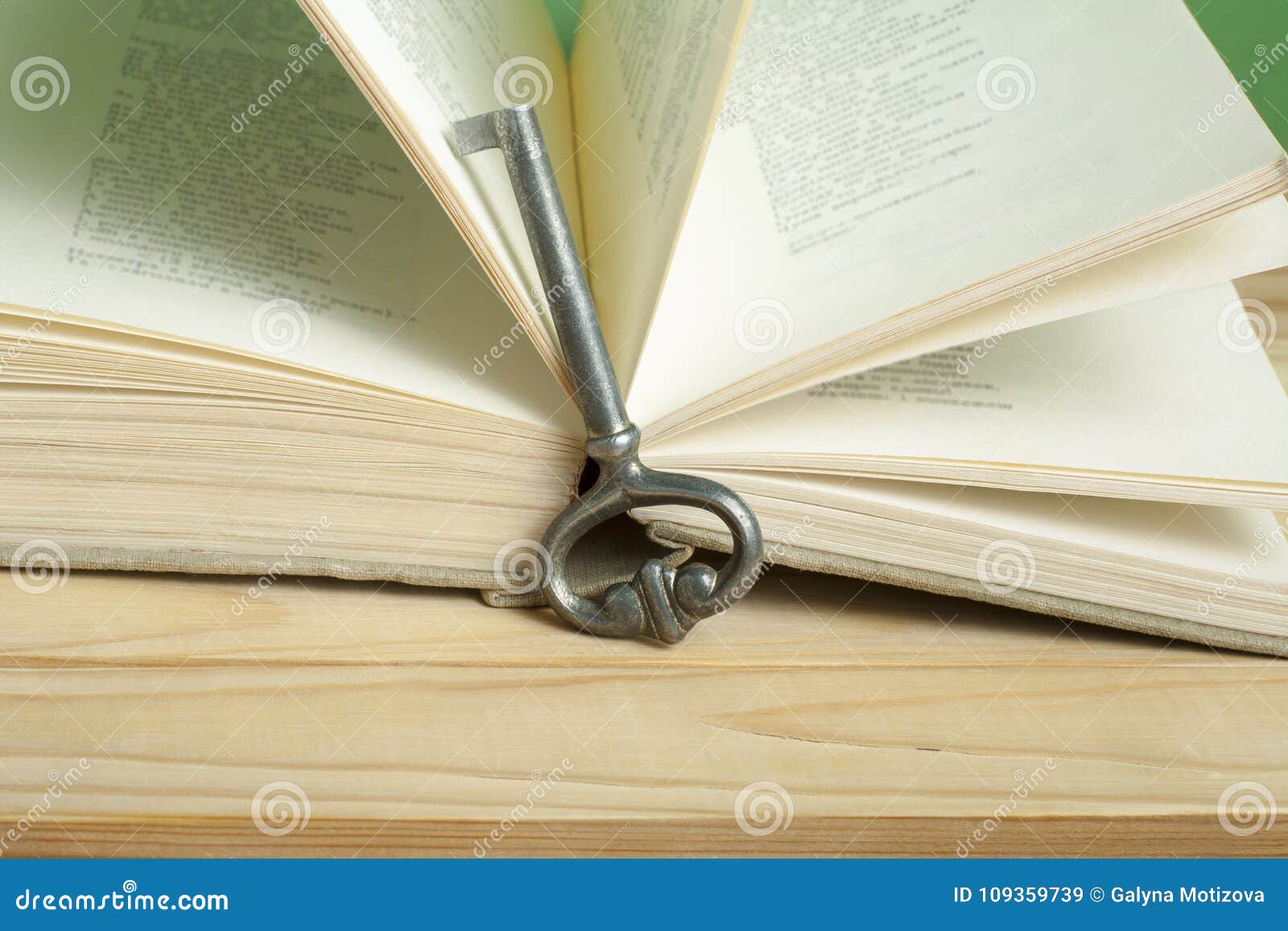 Key To Knowledge Concept. Book with Key on Wooden Background. Stock ...