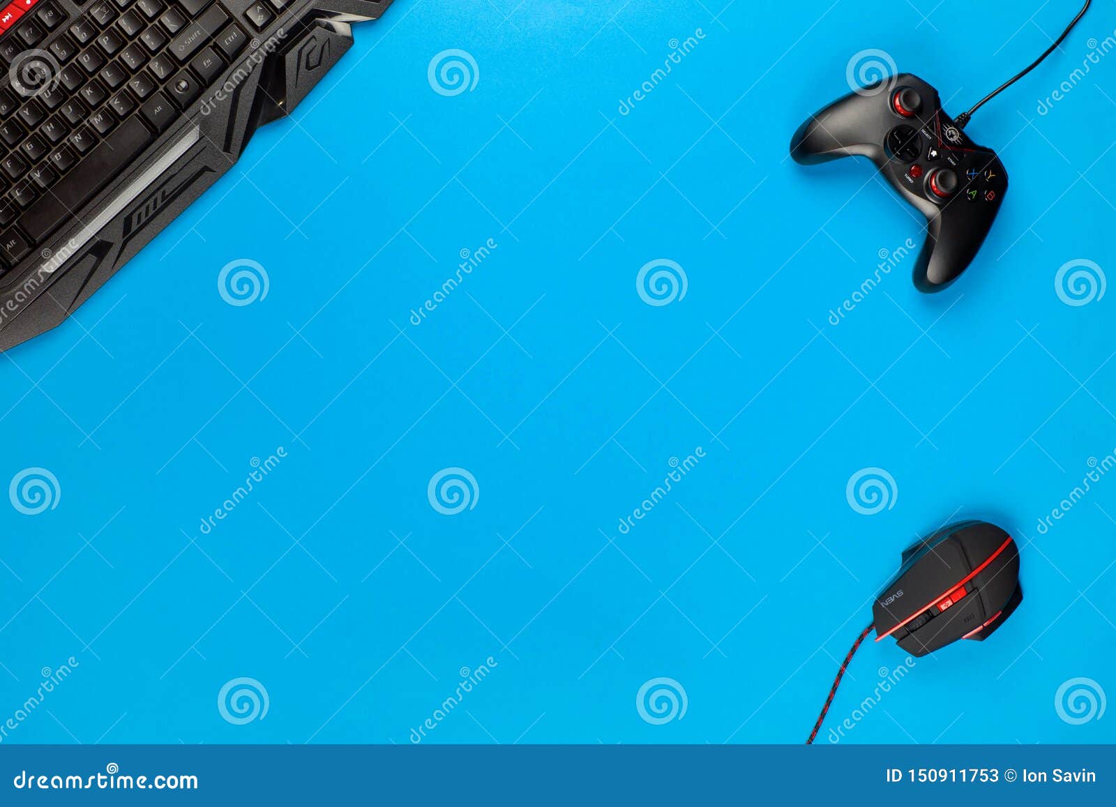 A Keyboard and a Mouse Next To a Controller on Blue Background, Shot ...