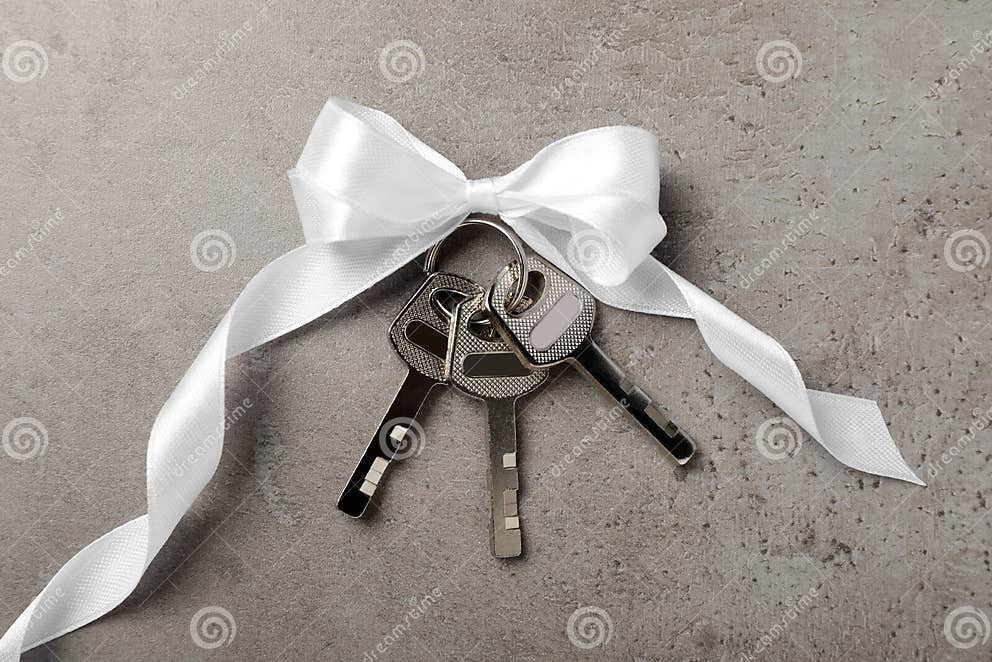 Keys with White Bow on Grey Table, Top View. Housewarming Party Stock ...