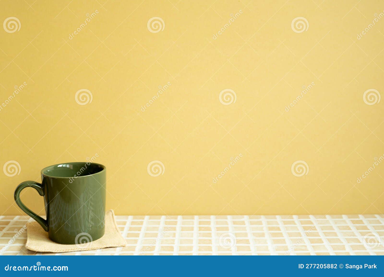Khaki Mug Cup on Check Tile Table. Yellow Wall Background Stock Photo ...