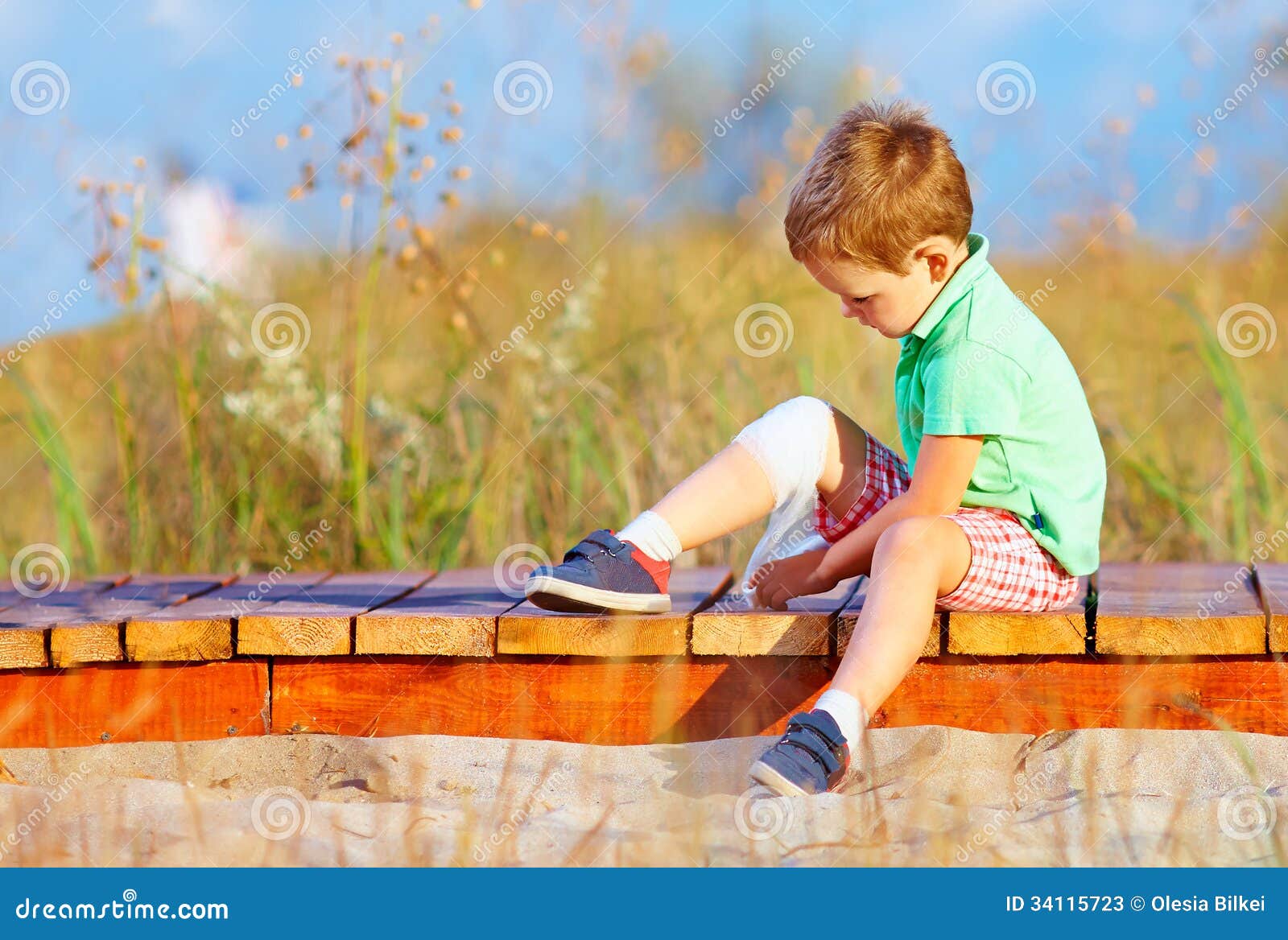 Kid bandaging injured leg stock image. Image of emergency - 34115723