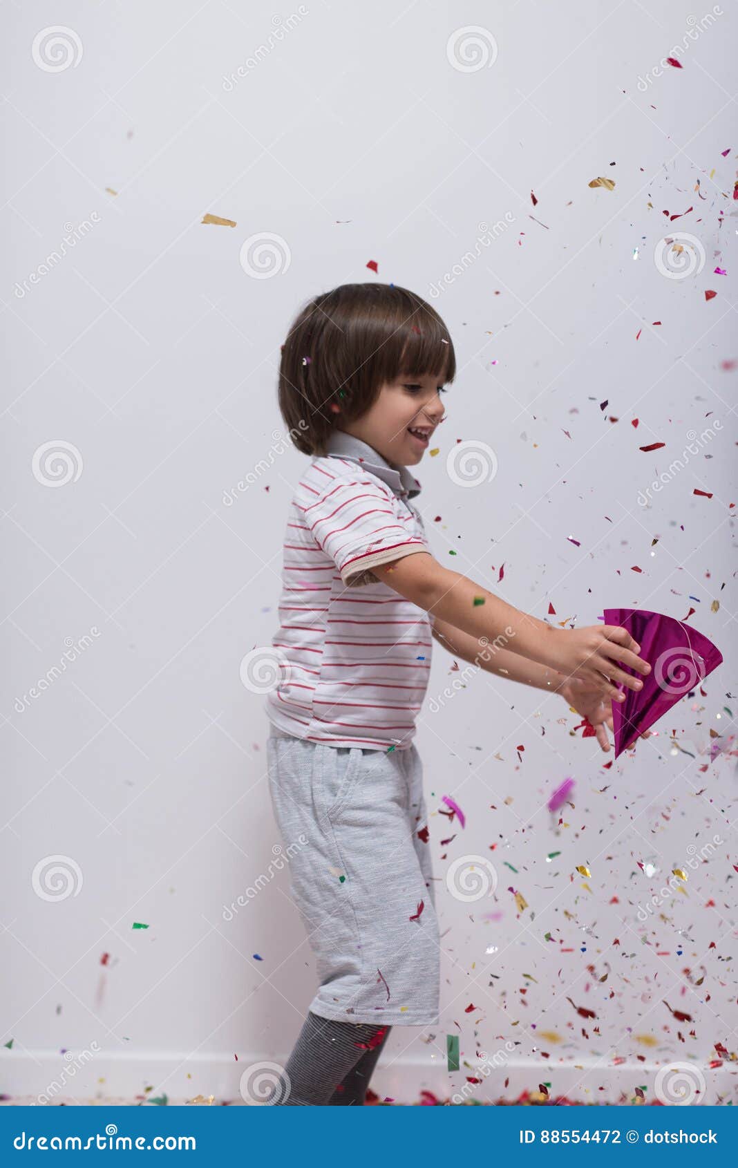 Kid blowing confetti stock photo. Image of celebration - 88554472