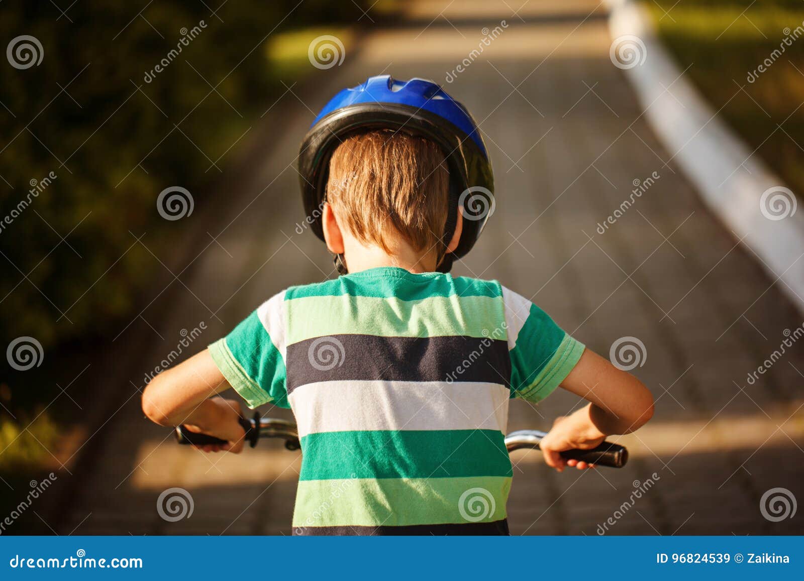 Kid Boy on a Bicycle at Asphalt Road in the Park. Back View. Stock ...